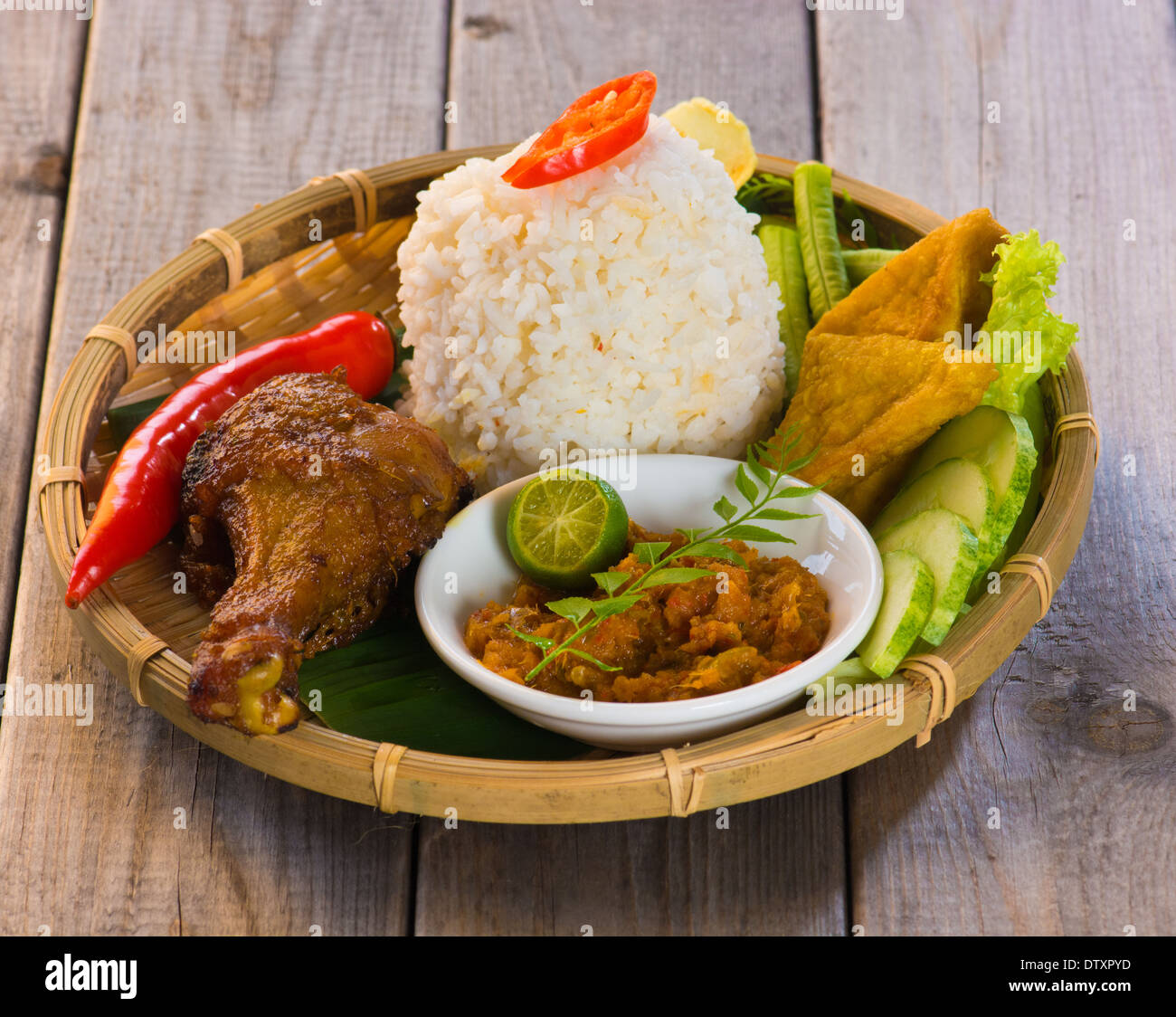 indonesian fried chicken rice on traditional background Stock Photo - Alamy