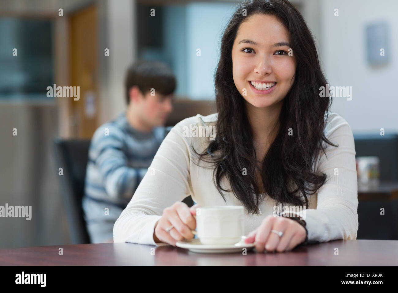 Happy student sitting in a coffee shop Stock Photo - Alamy