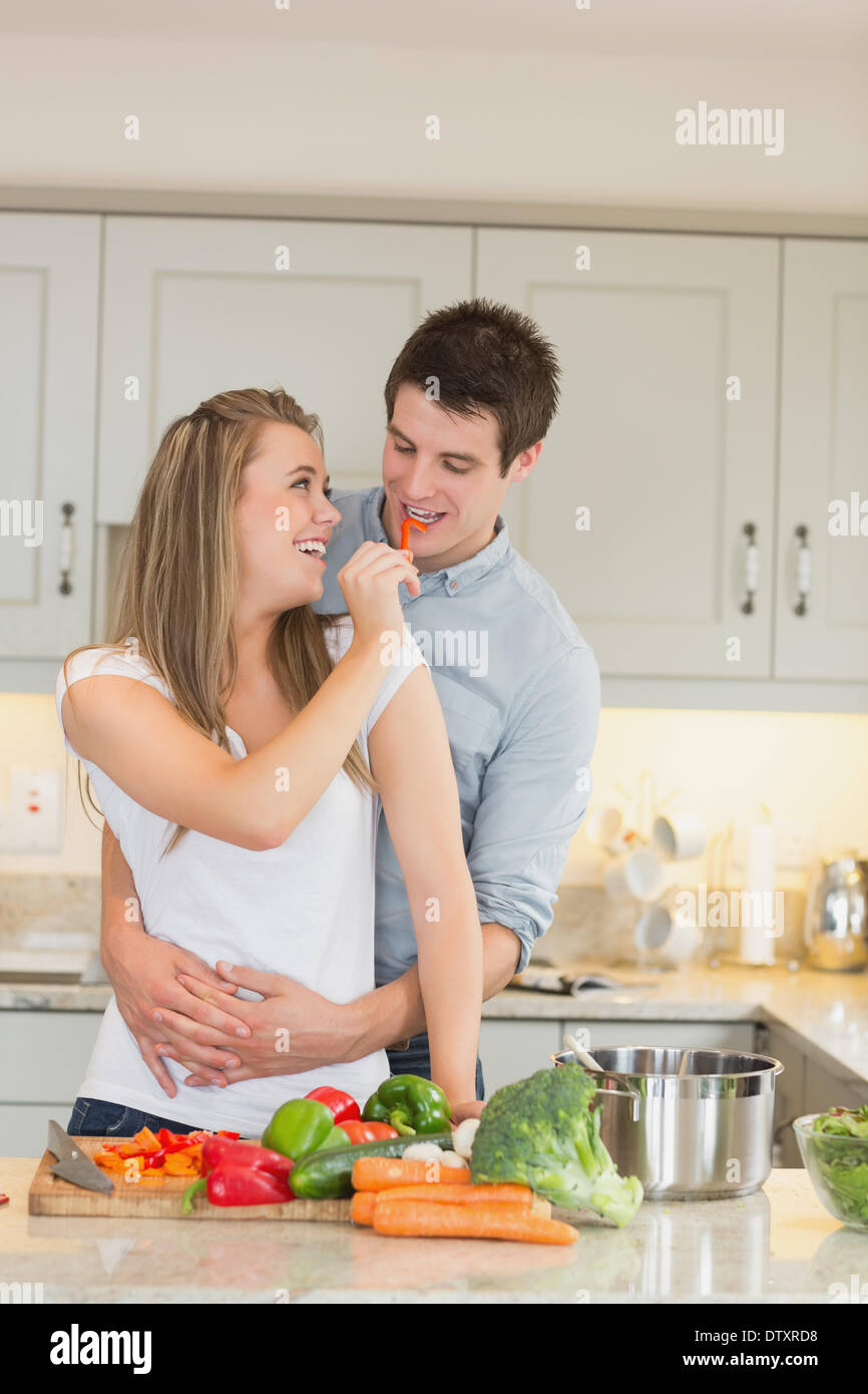 Woman feeding man with a pepper Stock Photo - Alamy