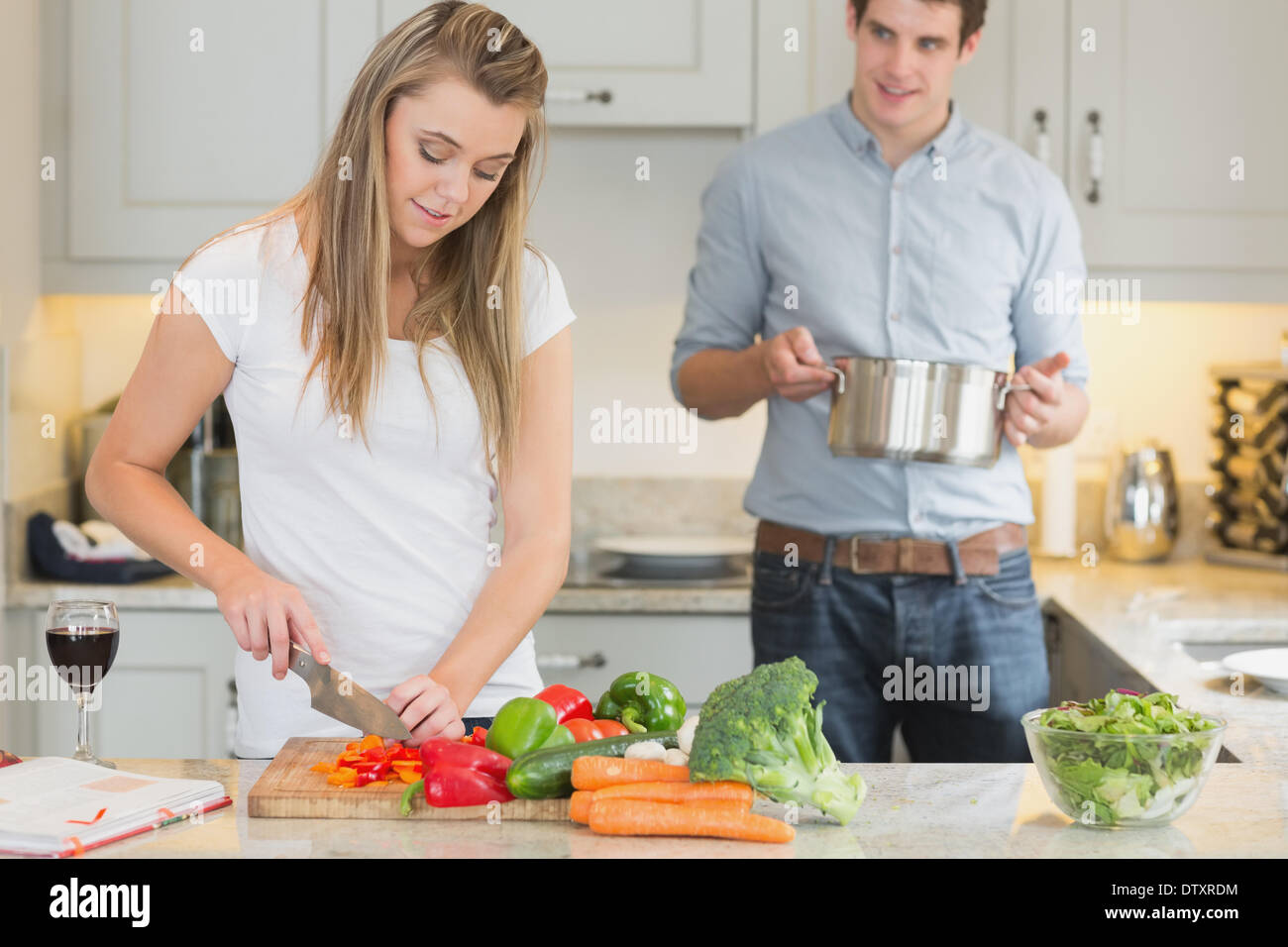 Man helping woman with cooking Stock Photo - Alamy