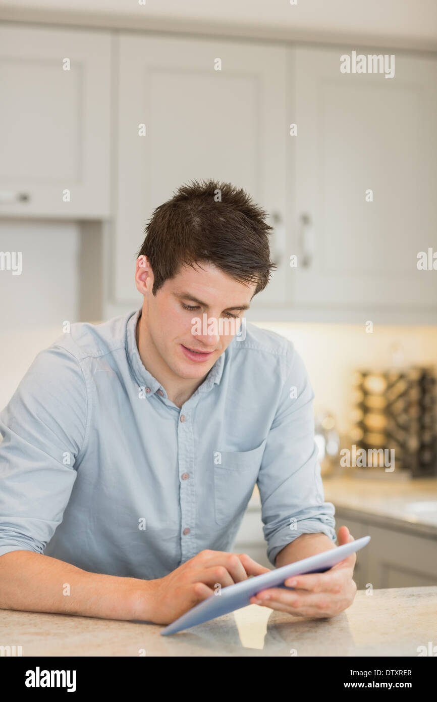 Man touching his tablet screen Stock Photo - Alamy