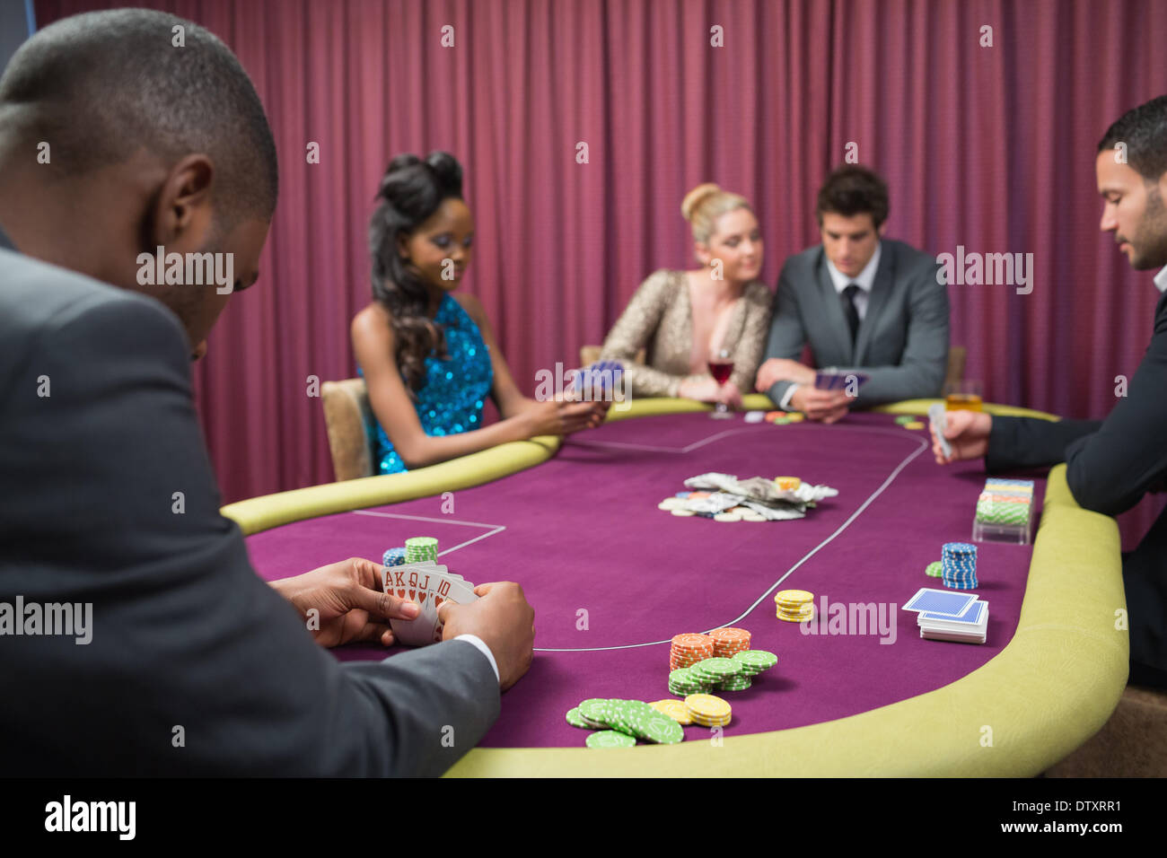 Man playing poker looking cards hi-res stock photography and images - Alamy