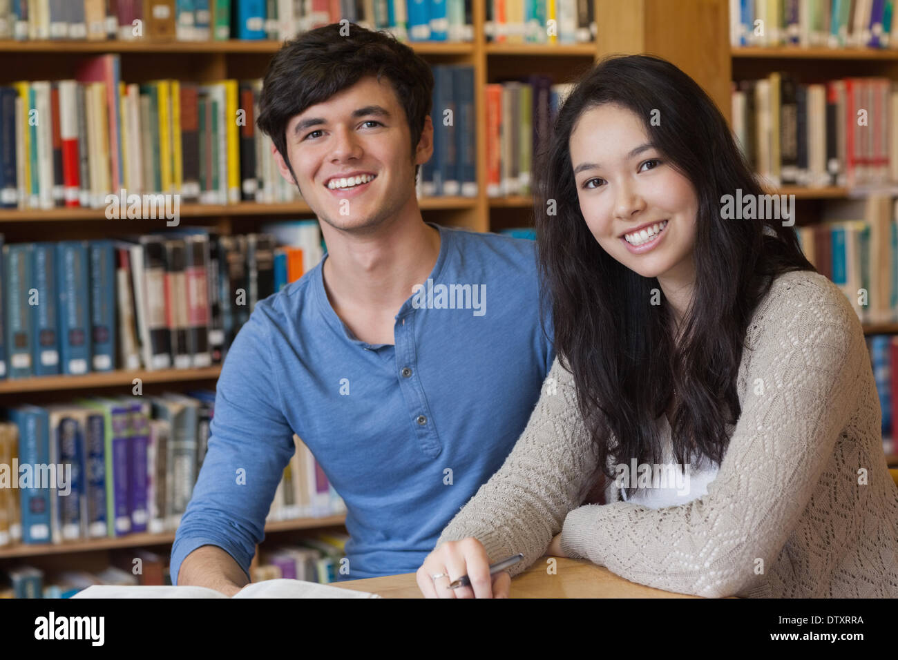 Two students in a library Stock Photo - Alamy