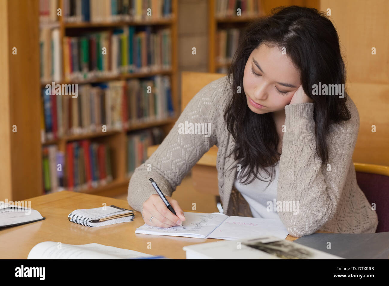 Bored student in a library learning Stock Photo - Alamy