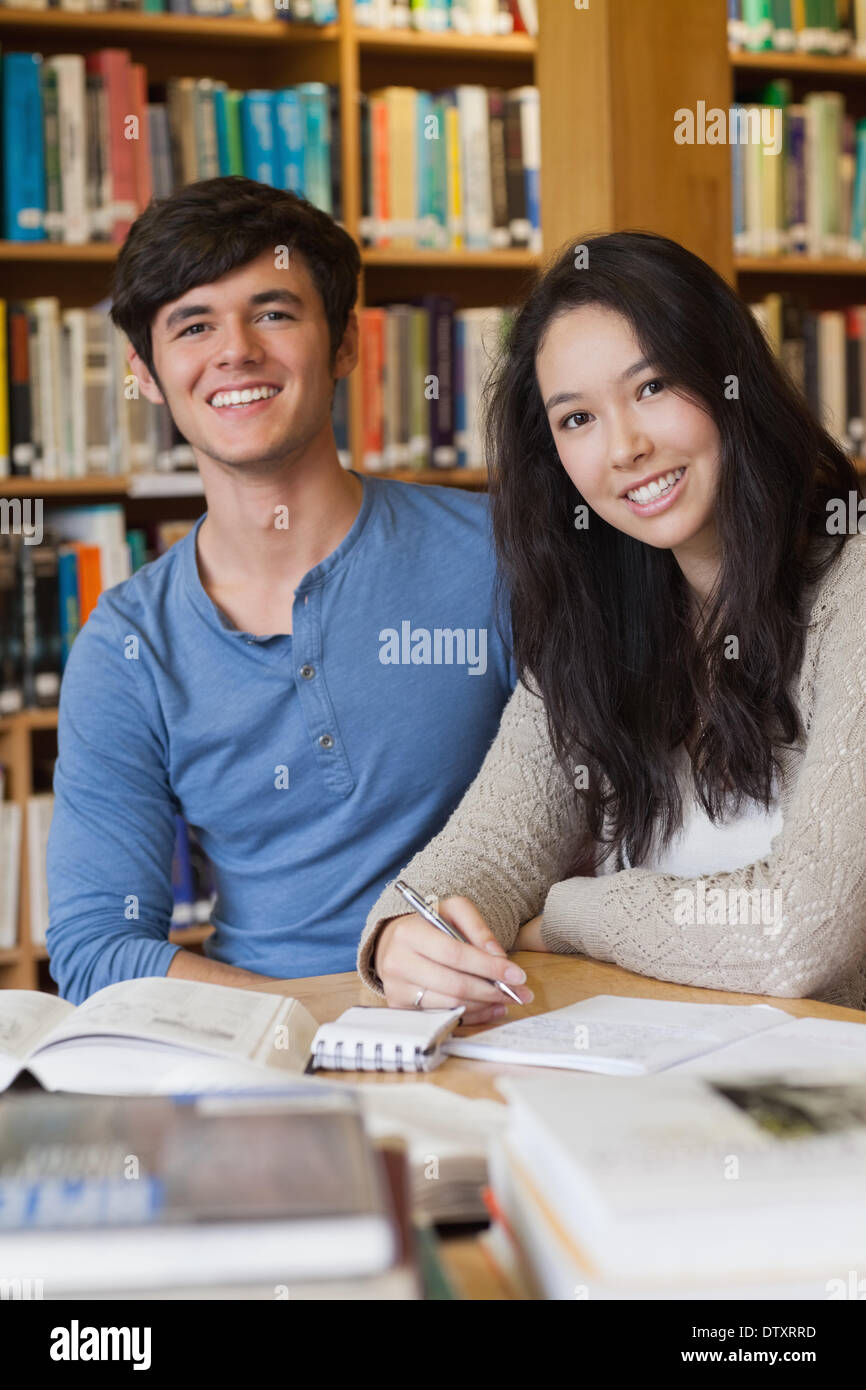 Two happy students in a library Stock Photo - Alamy