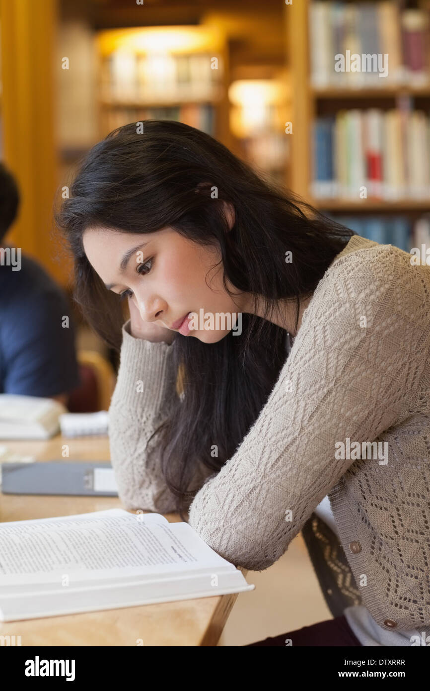 Student reading in a library Stock Photo - Alamy