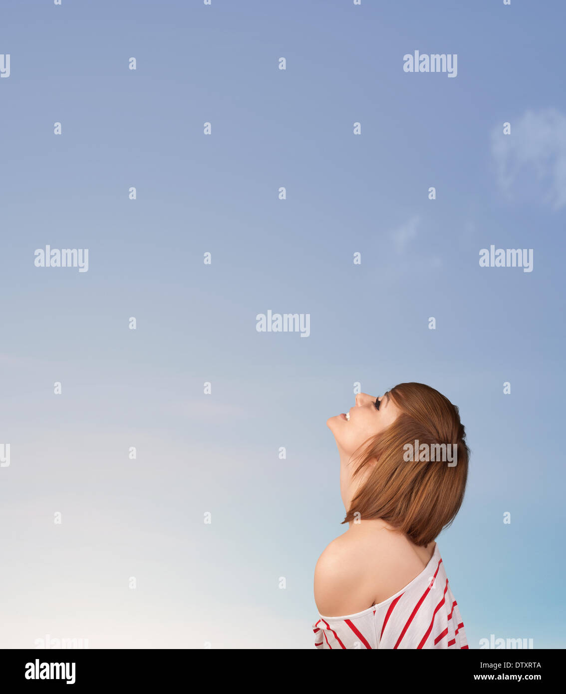 Girl looking at the blue sky copyspace Stock Photo - Alamy