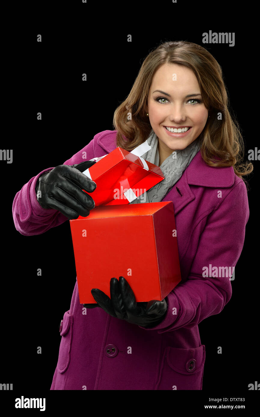 Young woman opening gift box isolated over black background Stock Photo ...