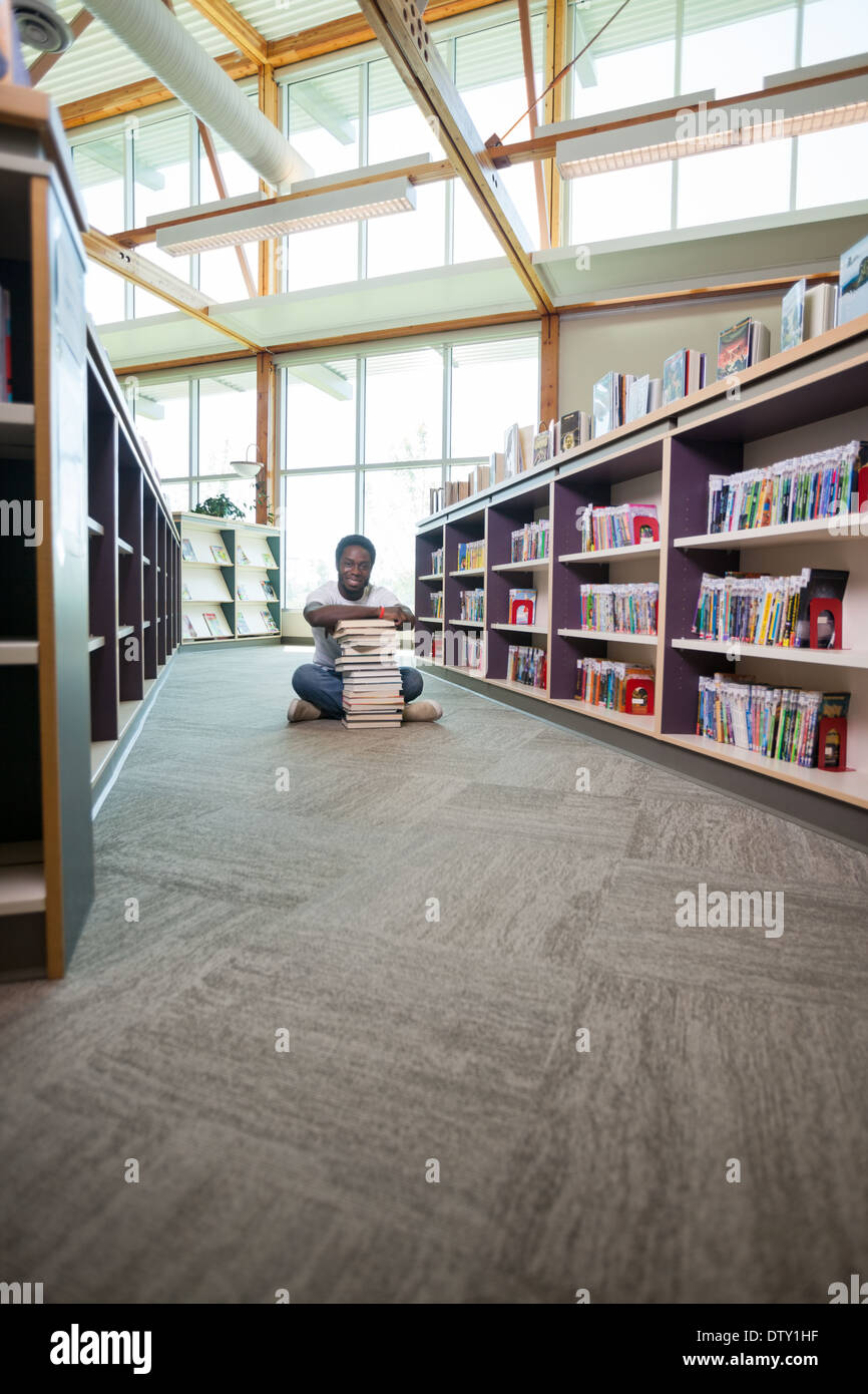Student With Stack Of Books In Library Stock Photo - Alamy
