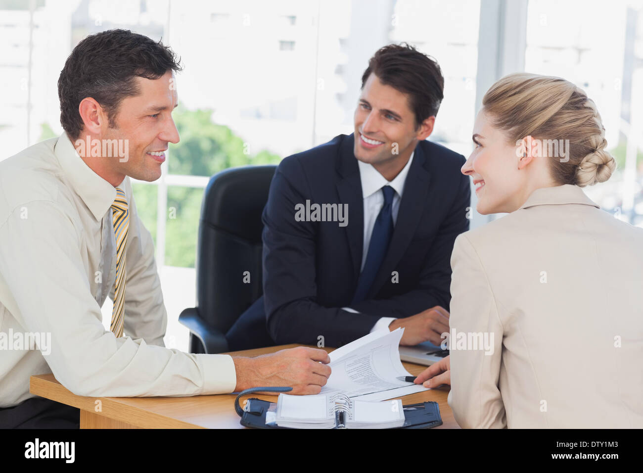 Business people smiling during a meeting Stock Photo - Alamy