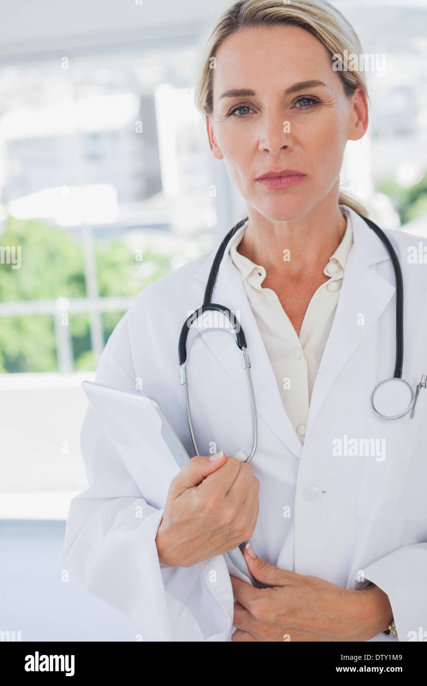 Serious blonde doctor standing Stock Photo - Alamy