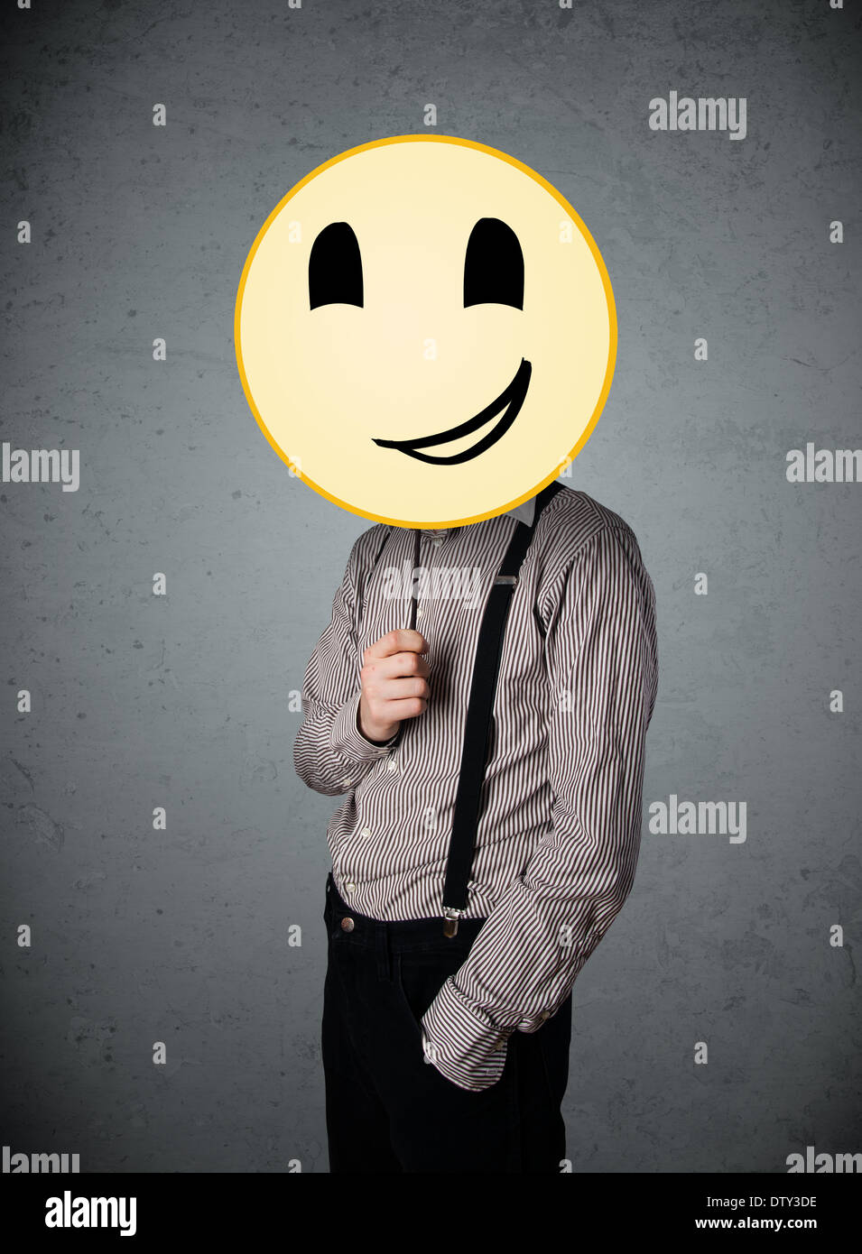 Businessman holding a smiley face emoticon Stock Photo - Alamy