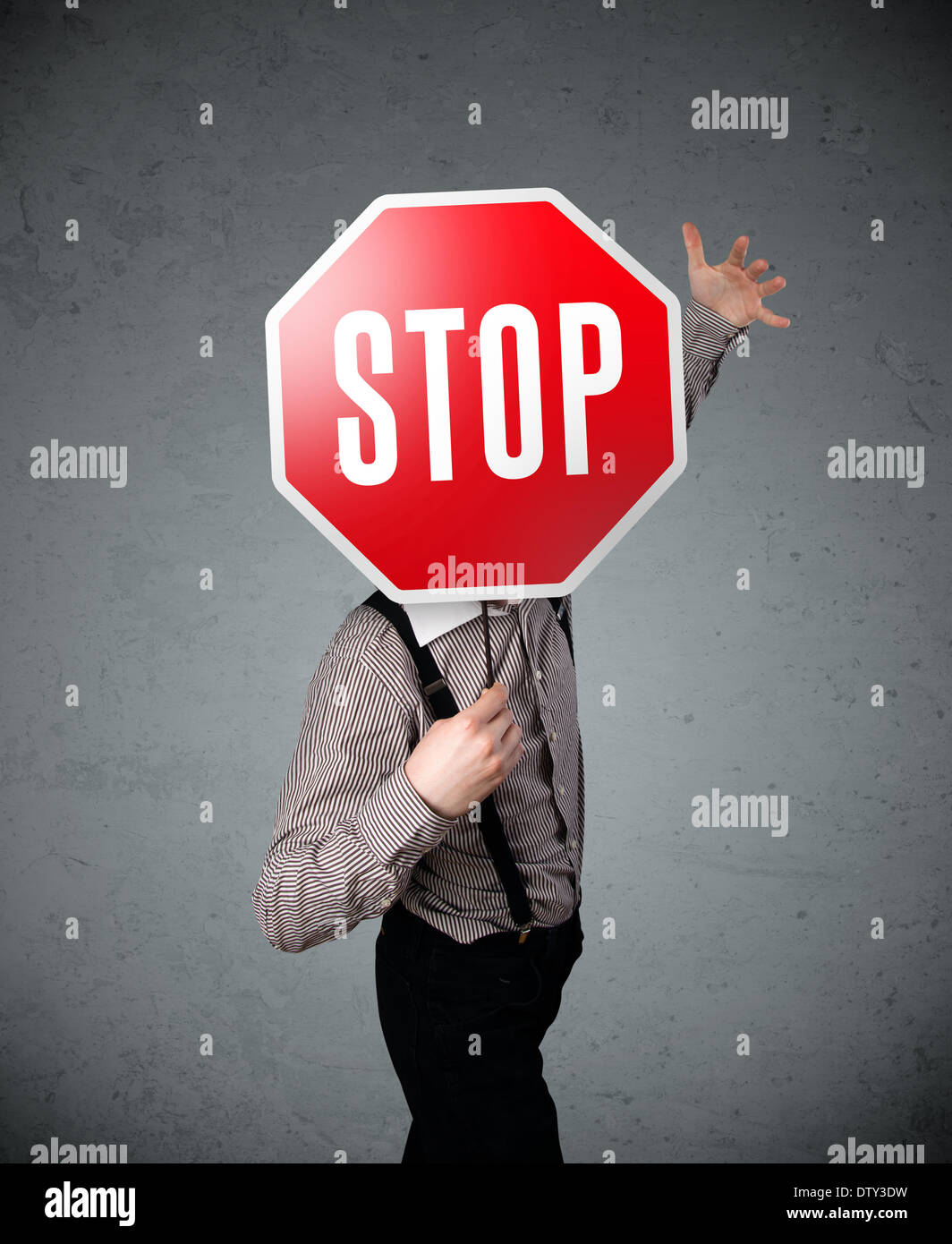 Businessman holding a stop sign Stock Photo - Alamy