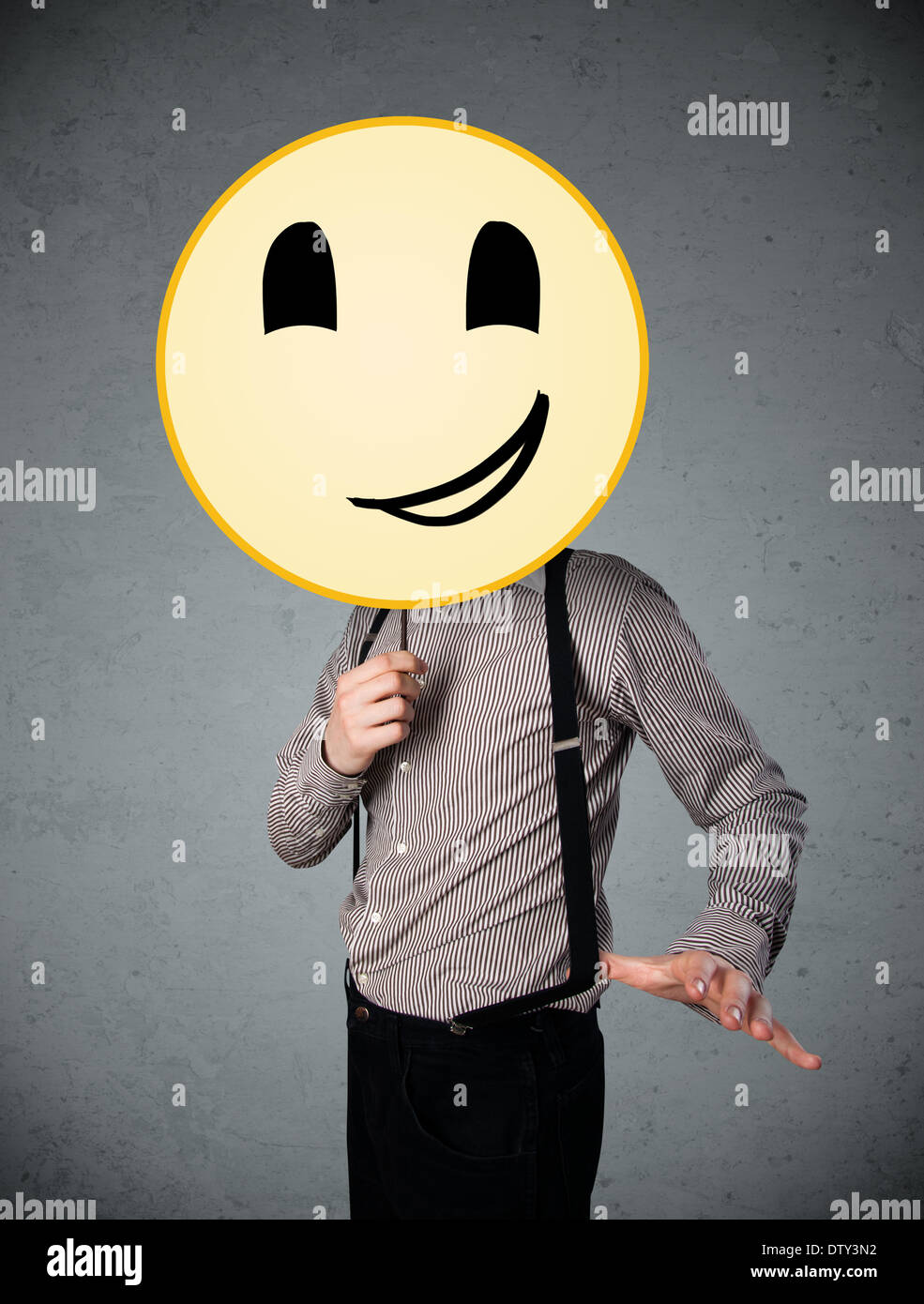 Businessman holding a smiley face emoticon Stock Photo - Alamy