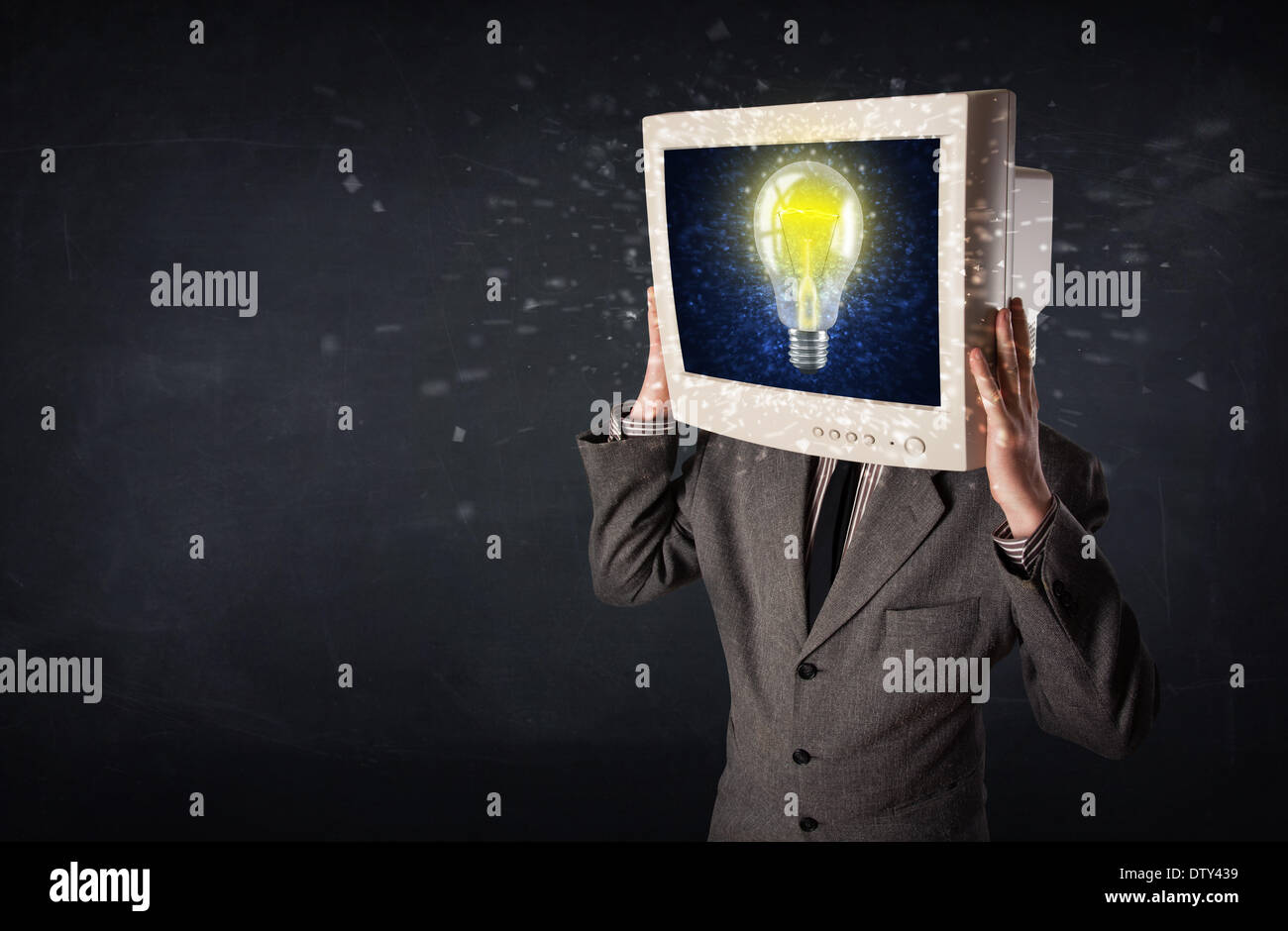 Business man with a pc monitor head and idea light bulb in the display ...