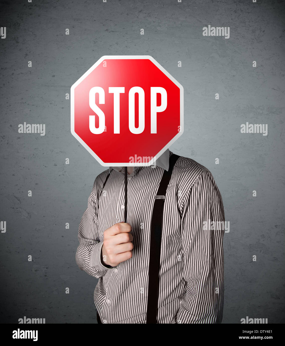Businessman holding a stop sign Stock Photo - Alamy