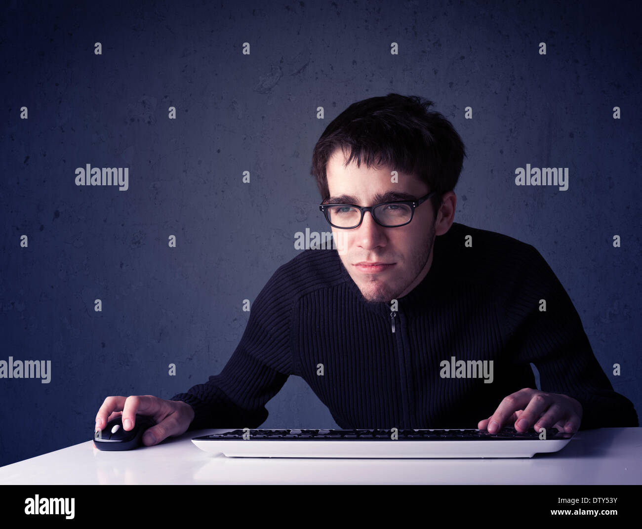 Hacker working with keyboard on blue background Stock Photo - Alamy
