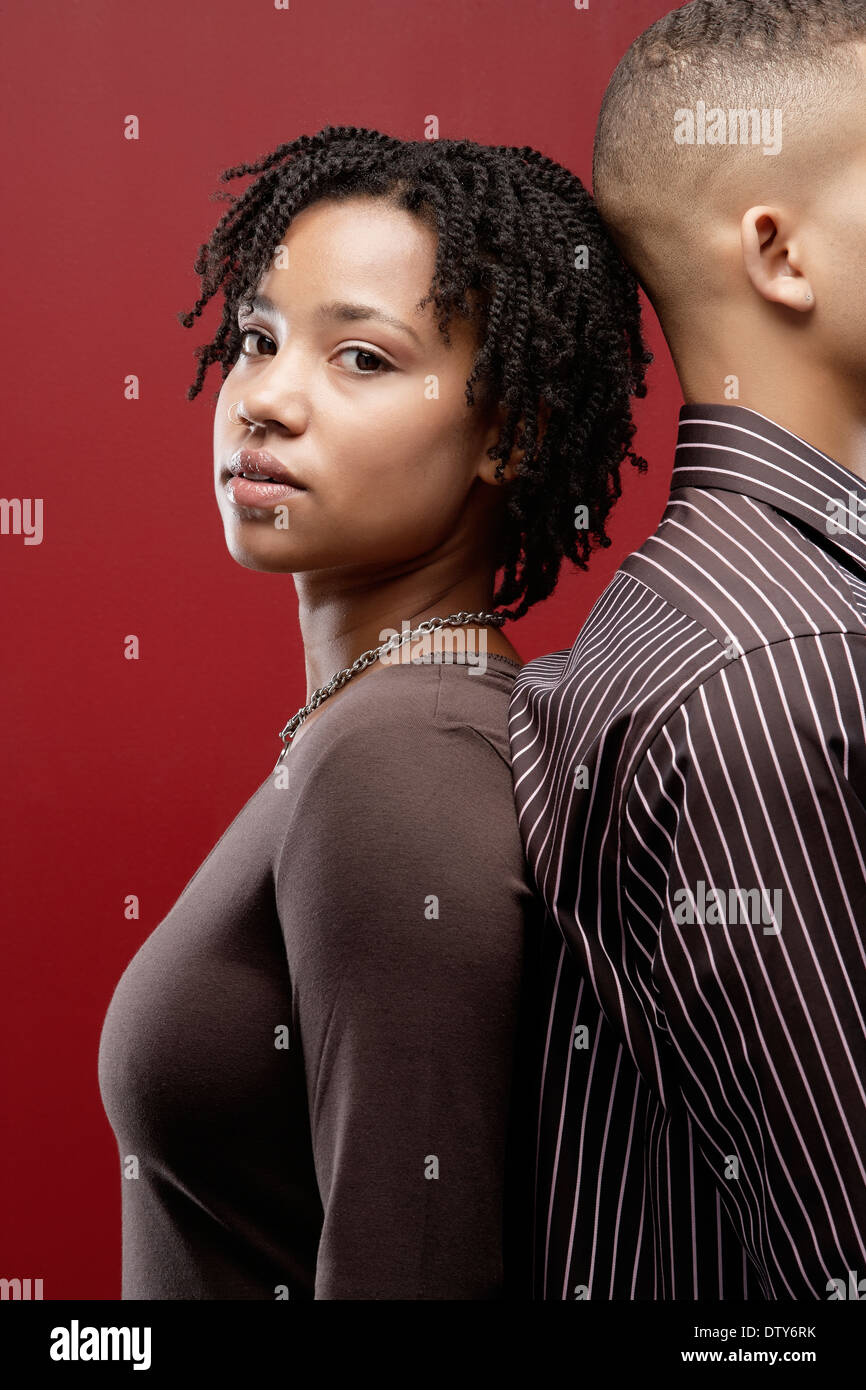 Couple standing back to back Stock Photo - Alamy