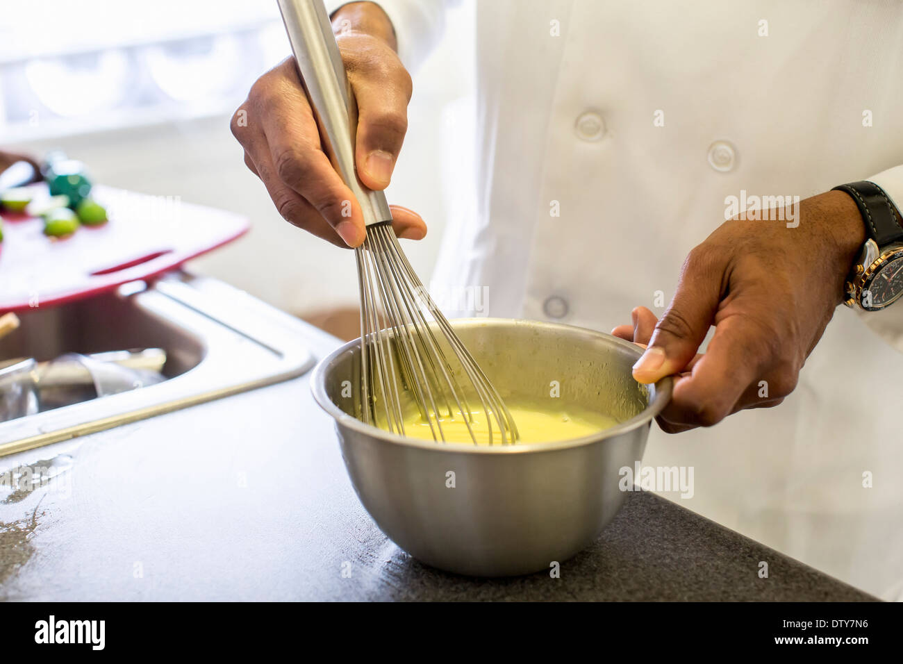 Black chef whisking eggs in restaurant Stock Photo - Alamy