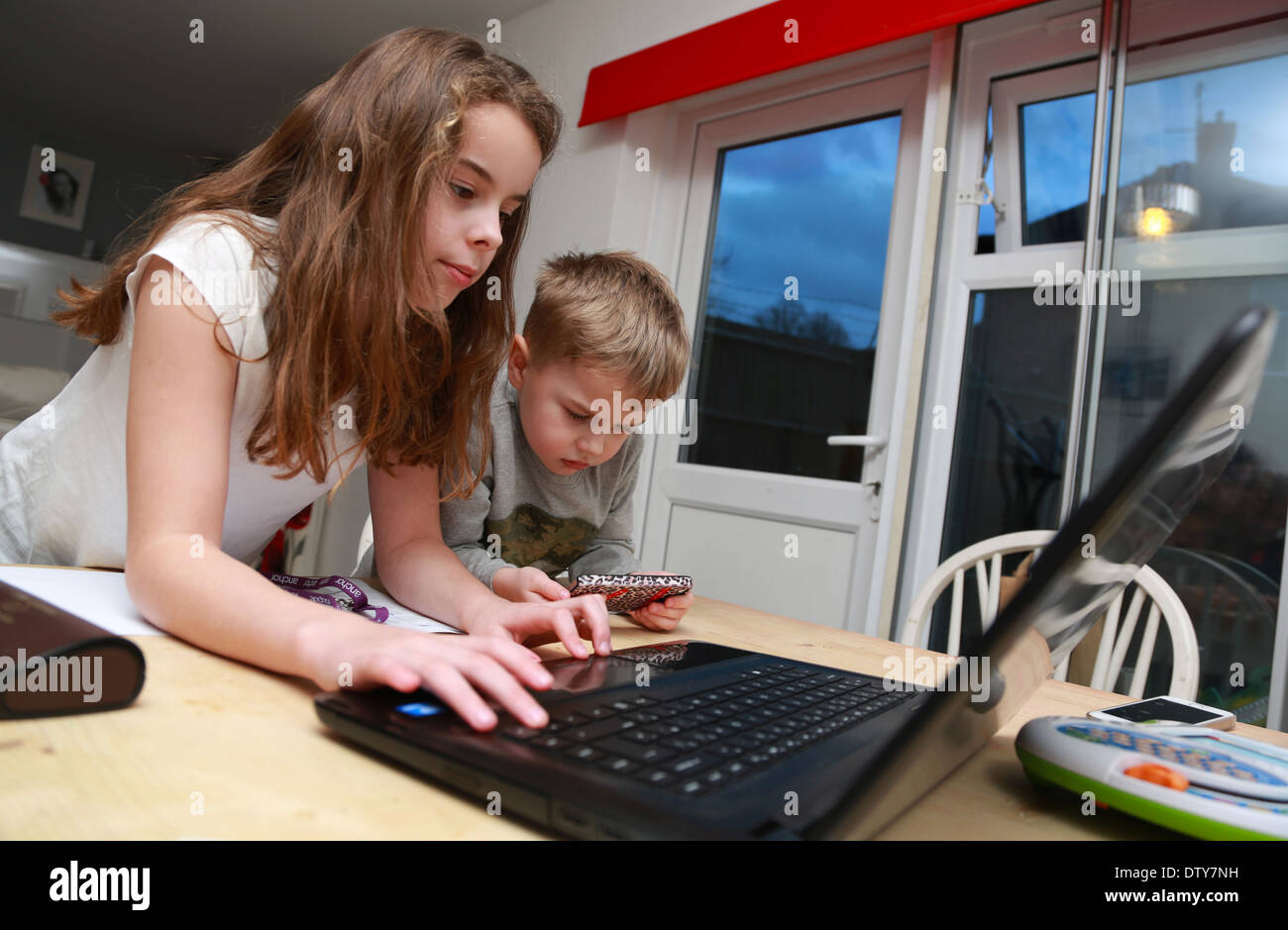 young brother and sister using a laptop Stock Photo - Alamy