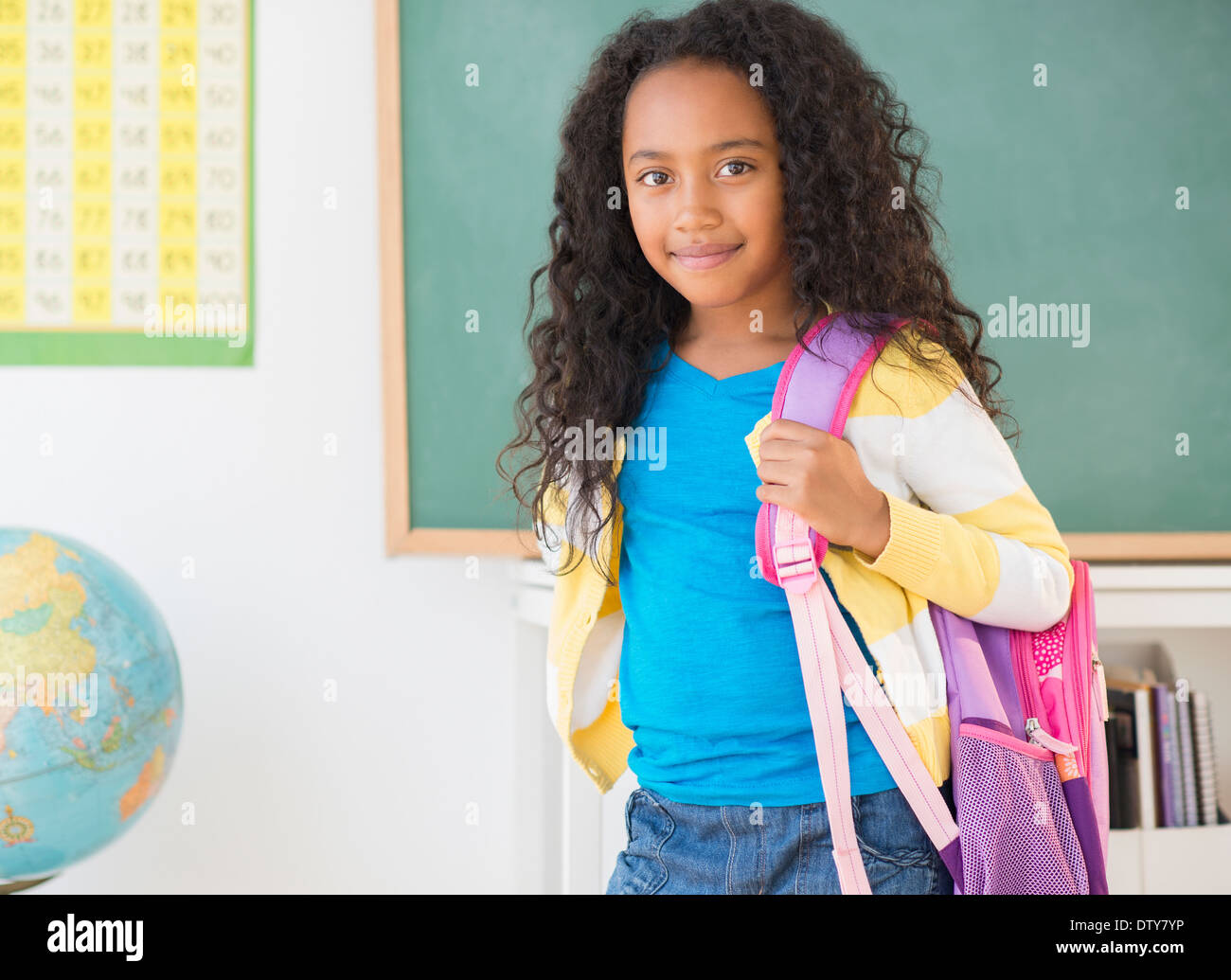 Mixed race student smiling in classroom Stock Photo - Alamy