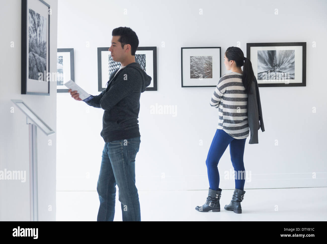 People admiring photograph art in gallery Stock Photo - Alamy