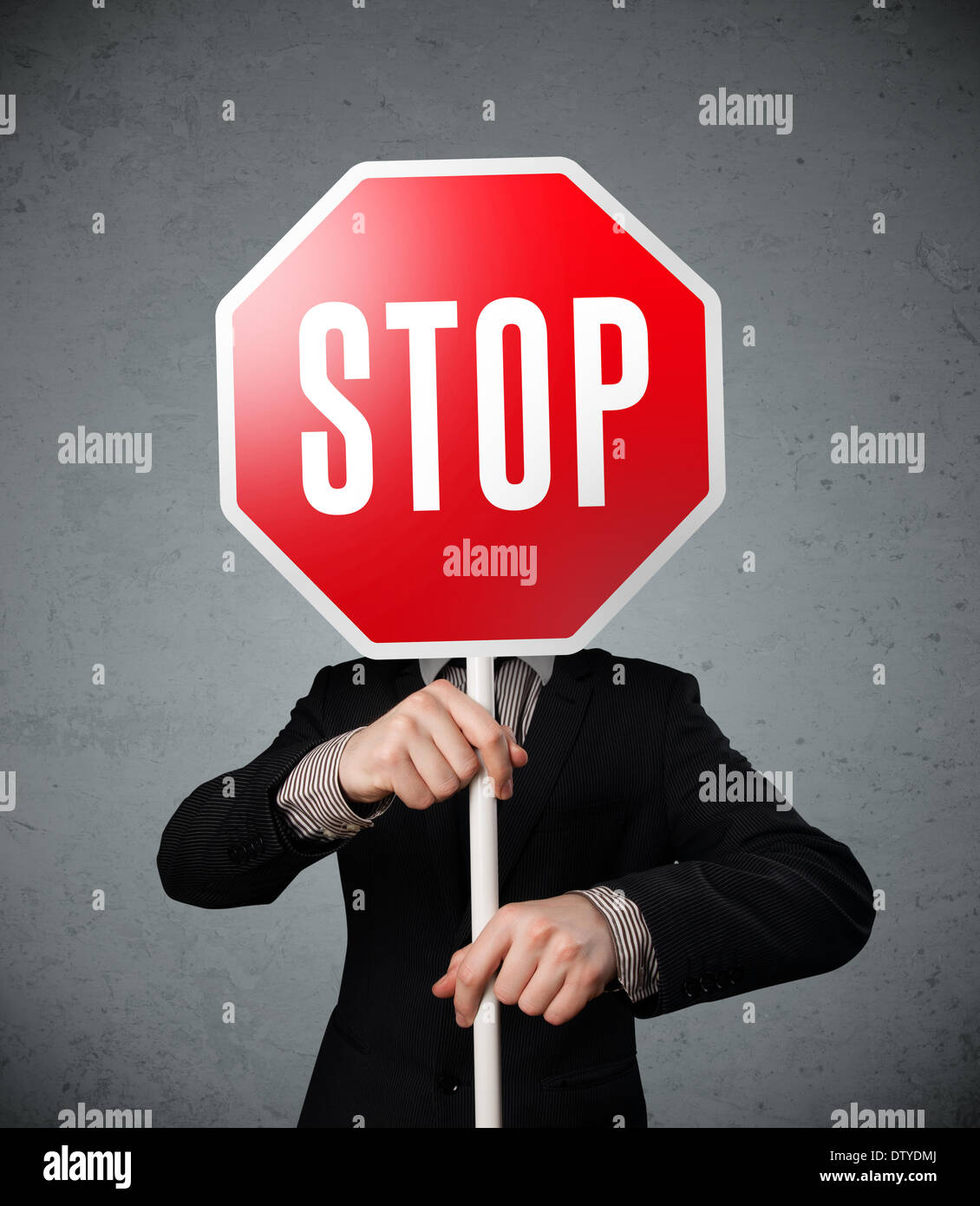 Businessman holding a stop sign Stock Photo - Alamy