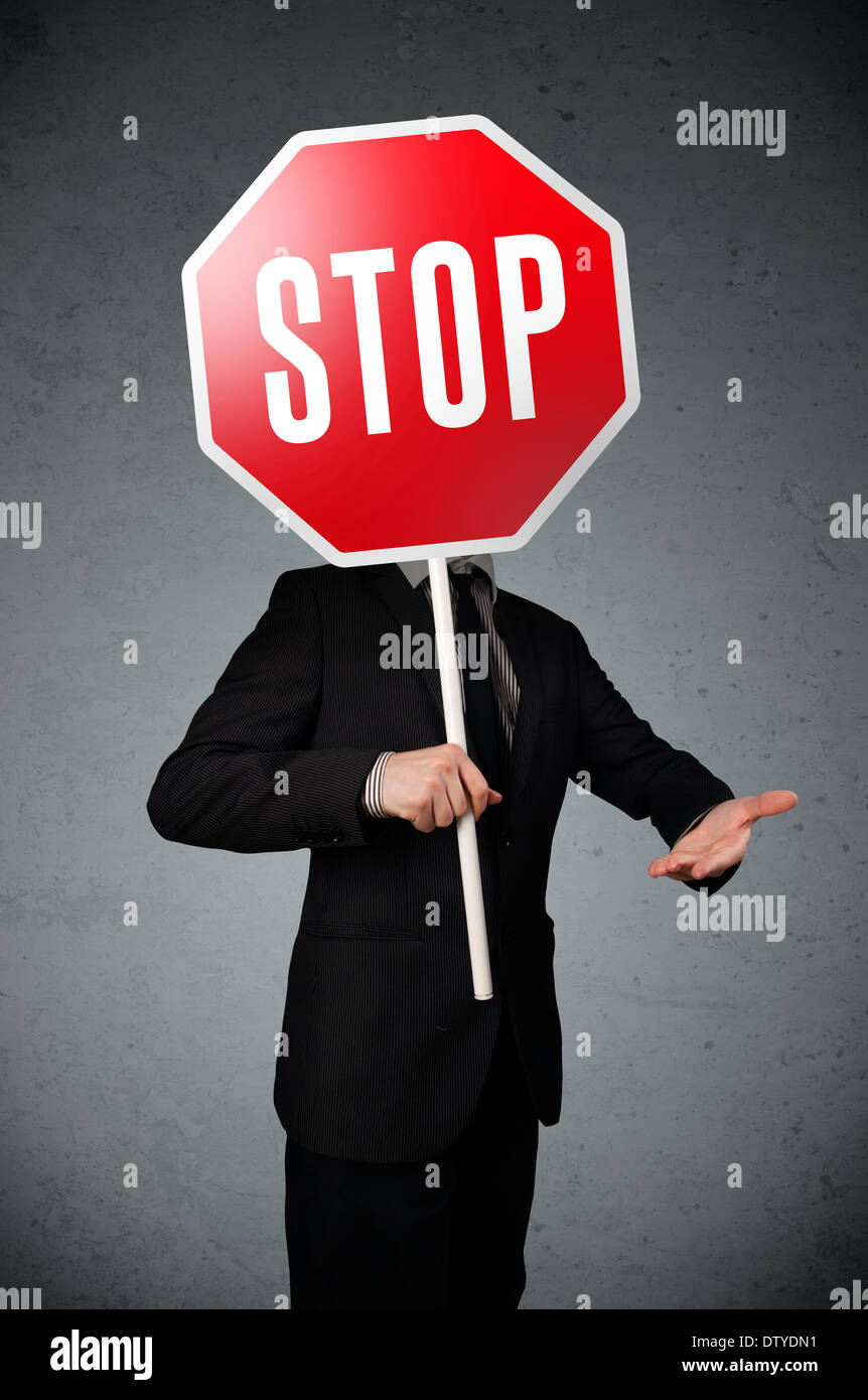 Businessman holding a stop sign Stock Photo - Alamy