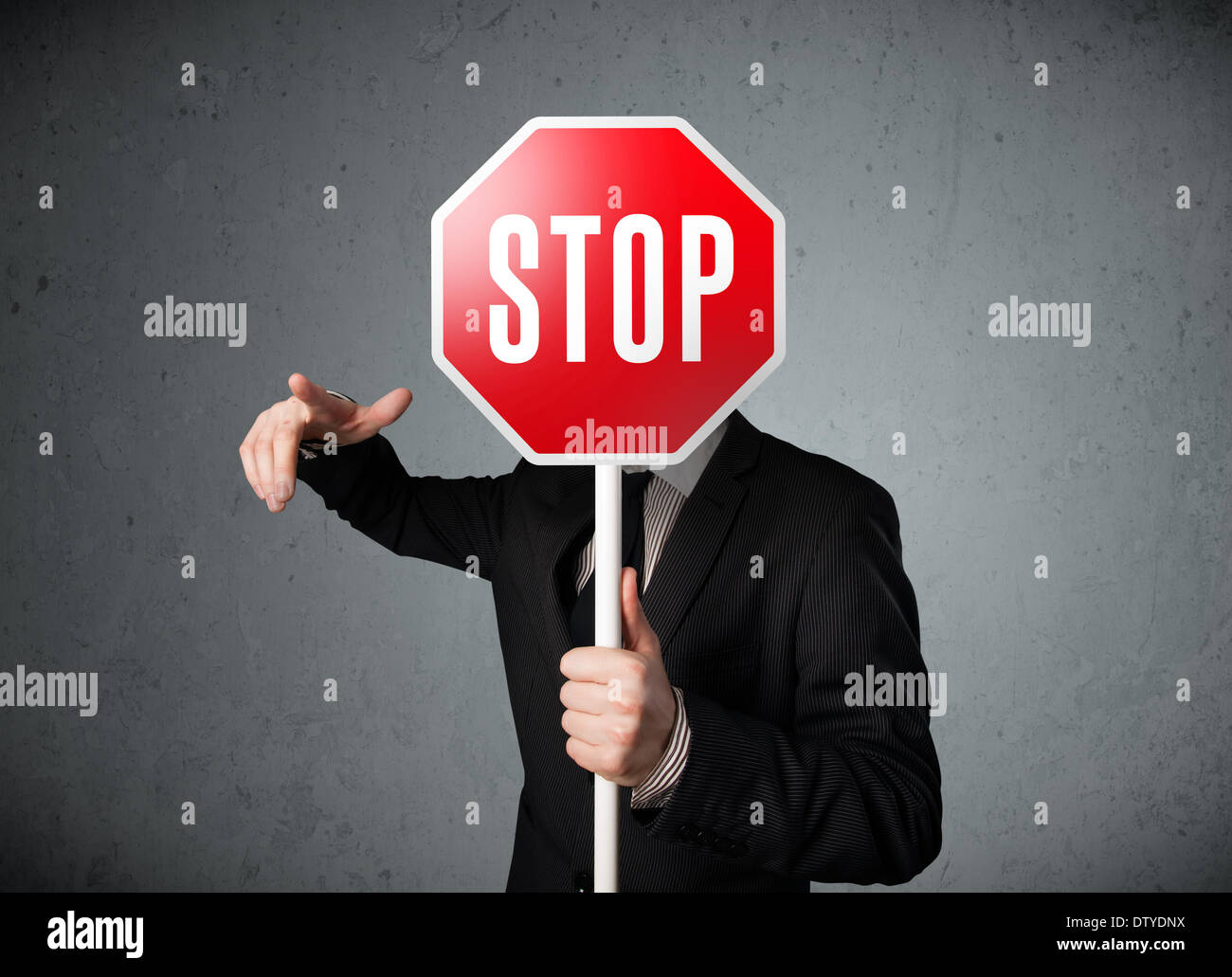 Businessman holding a stop sign Stock Photo - Alamy