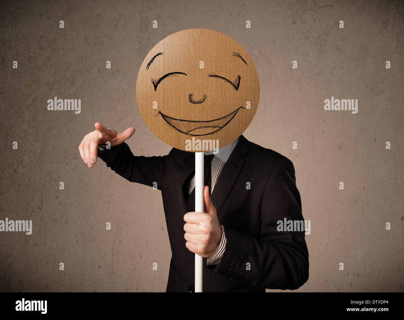 Businessman holding a smiley face board Stock Photo - Alamy