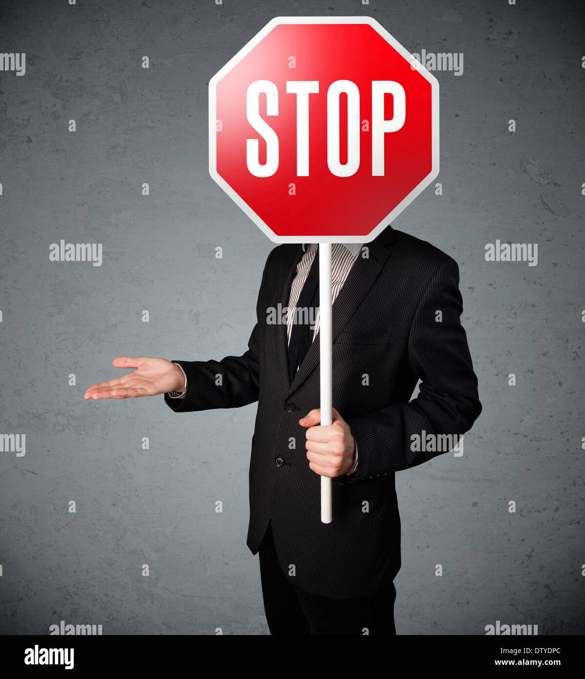 Businessman holding a stop sign Stock Photo - Alamy