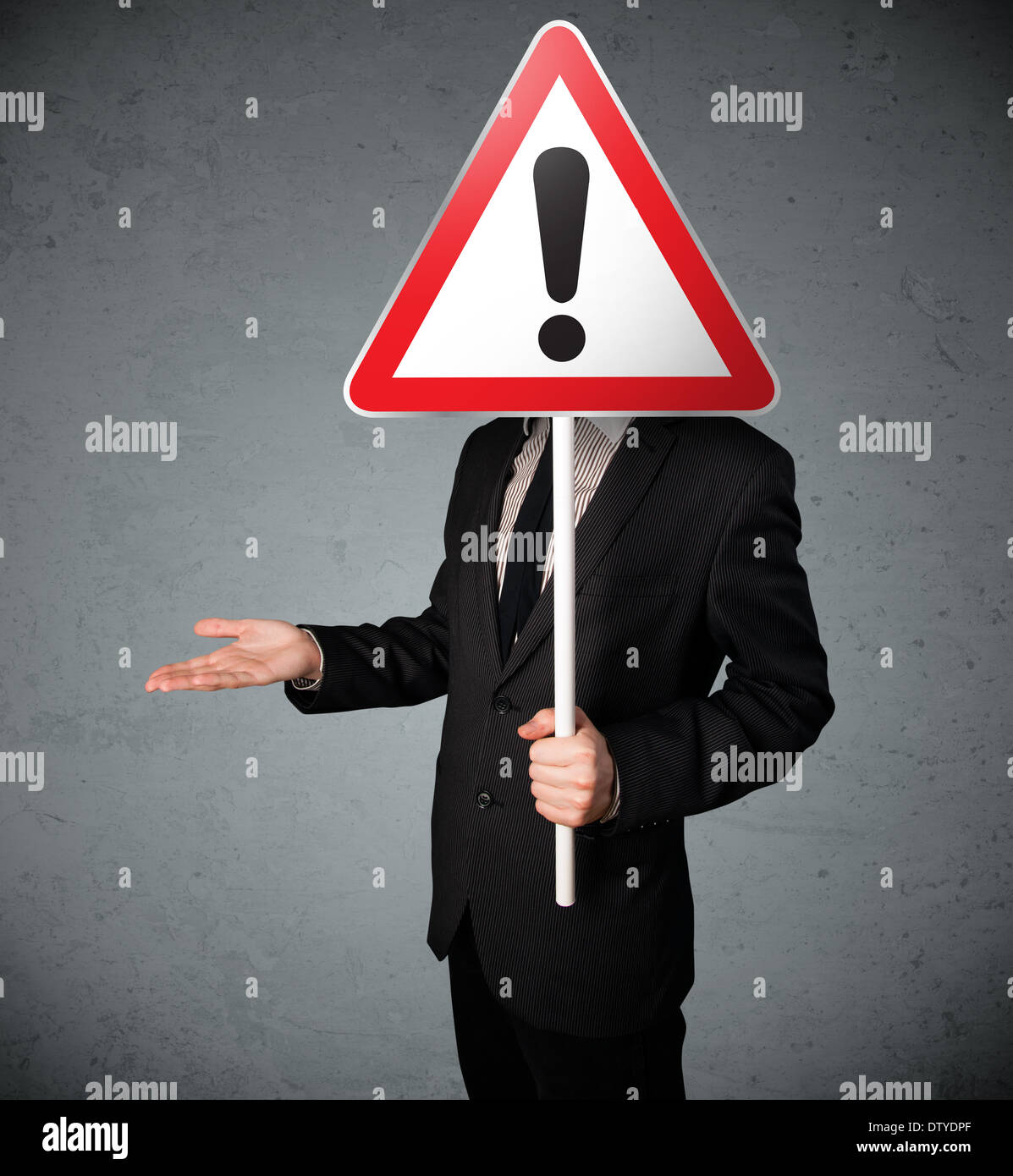 Businessman holding an exclamation road sign Stock Photo - Alamy