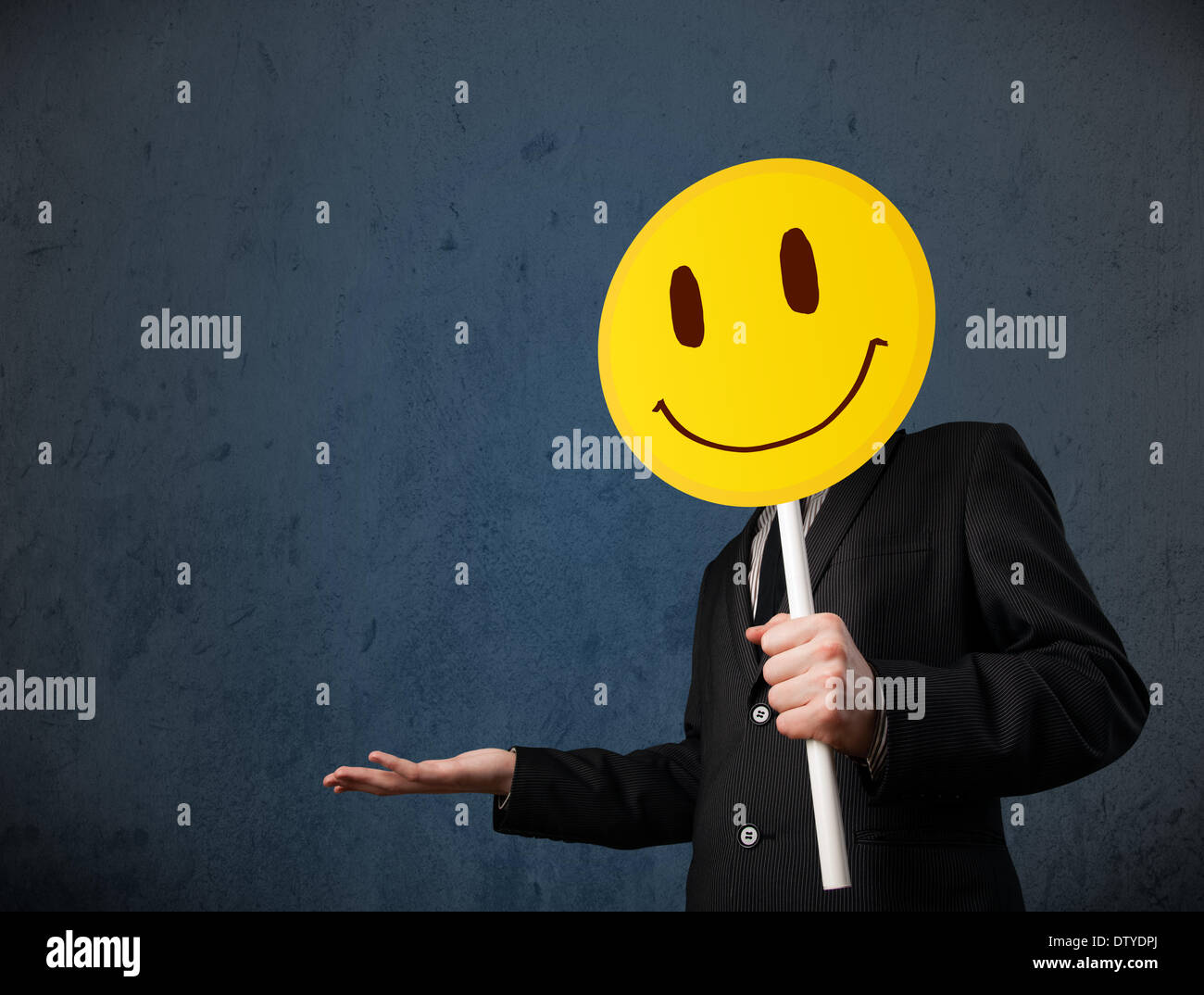 Businessman holding a smiley face emoticon Stock Photo - Alamy
