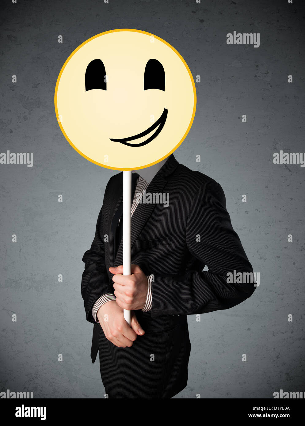 Businessman holding a smiley face emoticon Stock Photo - Alamy