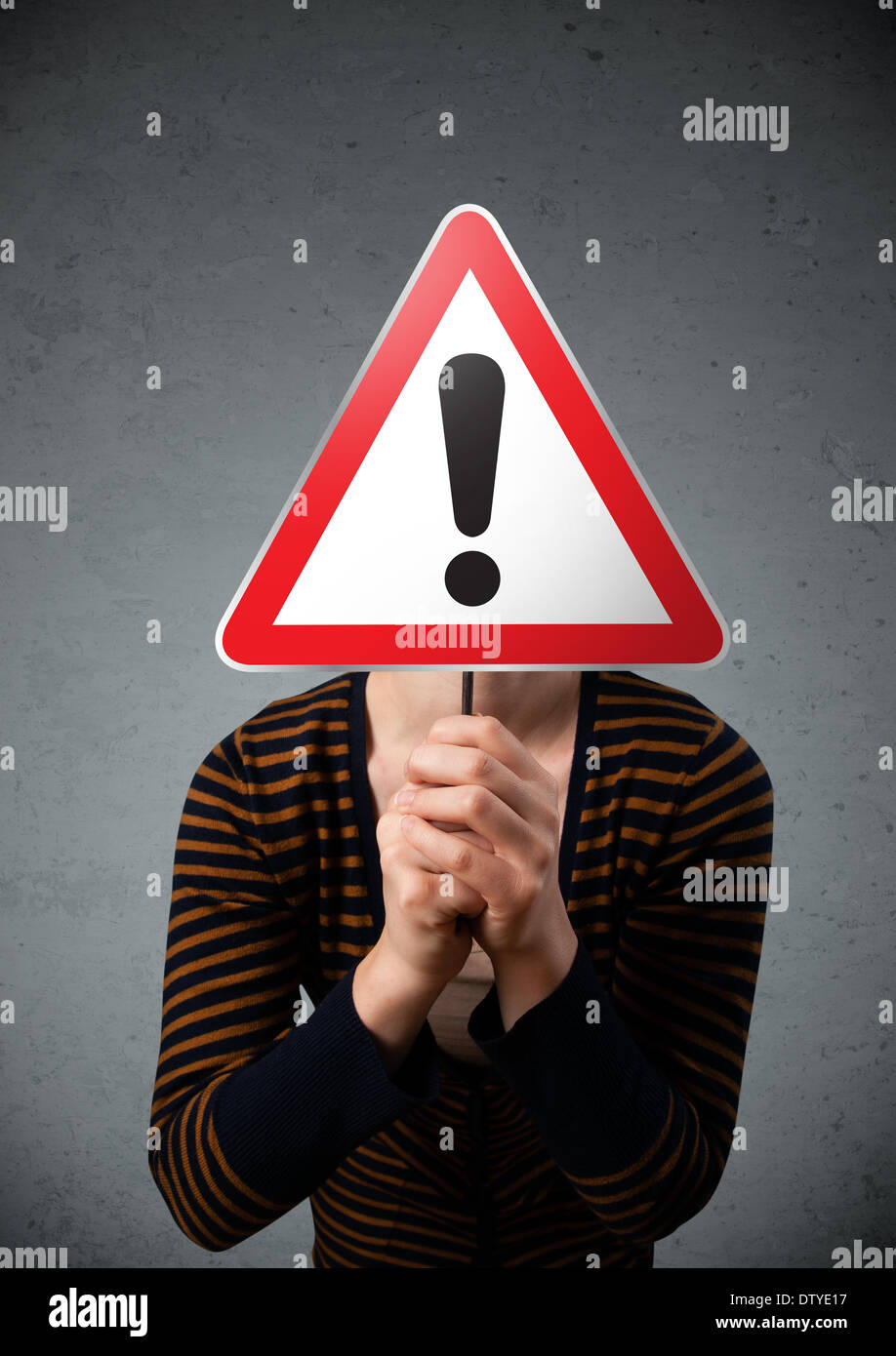 Young woman holding an exclamation road sign Stock Photo - Alamy