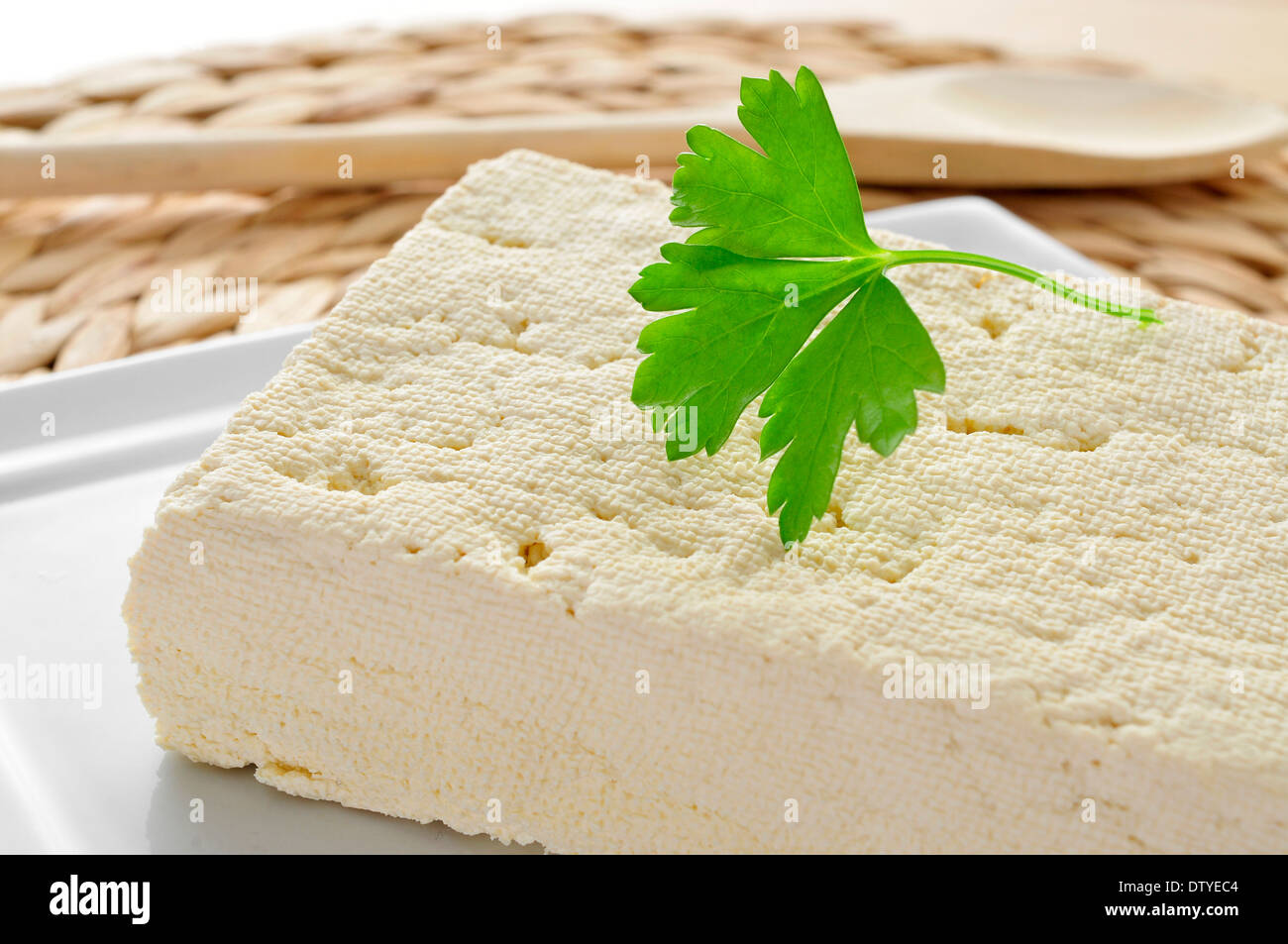 closeup of a block of tofu in a plate on a worktop Stock Photo - Alamy