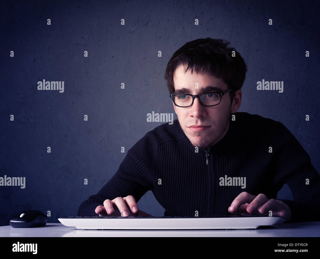 Hacker working with keyboard on blue background Stock Photo - Alamy