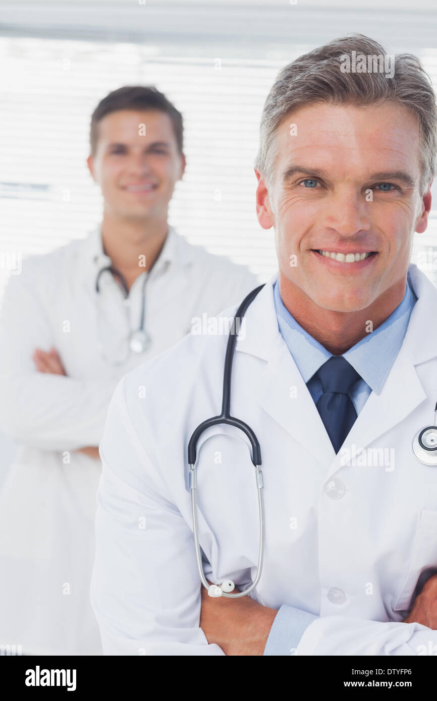 Confident doctor arms folded colleagues hi-res stock photography and ...
