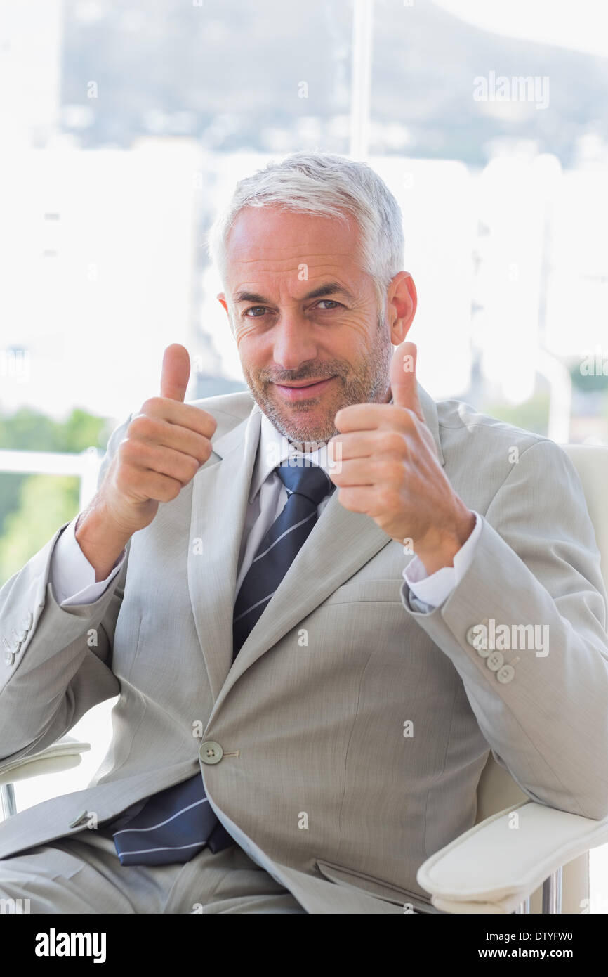 Happy businessman giving thumbs up Stock Photo - Alamy