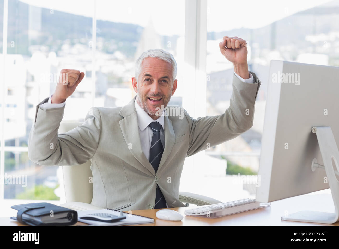 Cheering businessman sitting desk hi-res stock photography and images ...