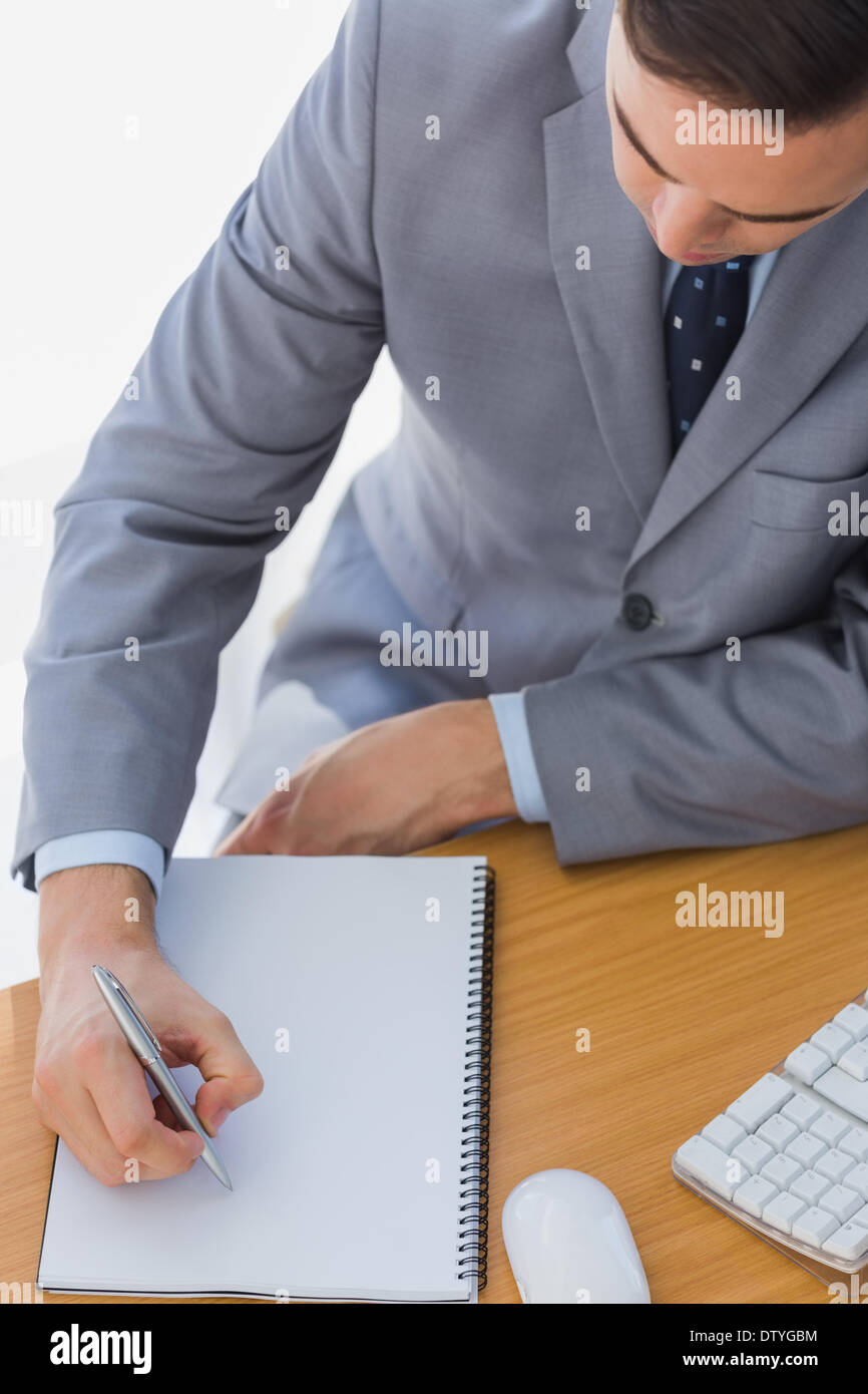 Businessman writing notes on notepad hi-res stock photography and ...