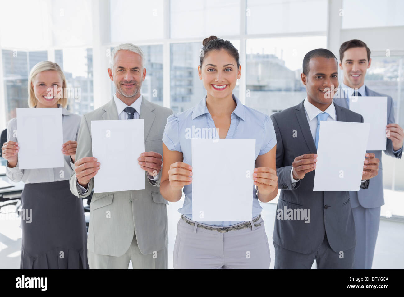 Business team showing blank pages Stock Photo - Alamy