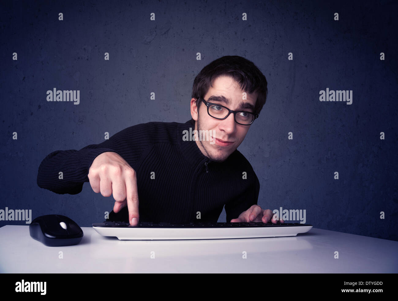 Hacker working with keyboard on blue background Stock Photo - Alamy