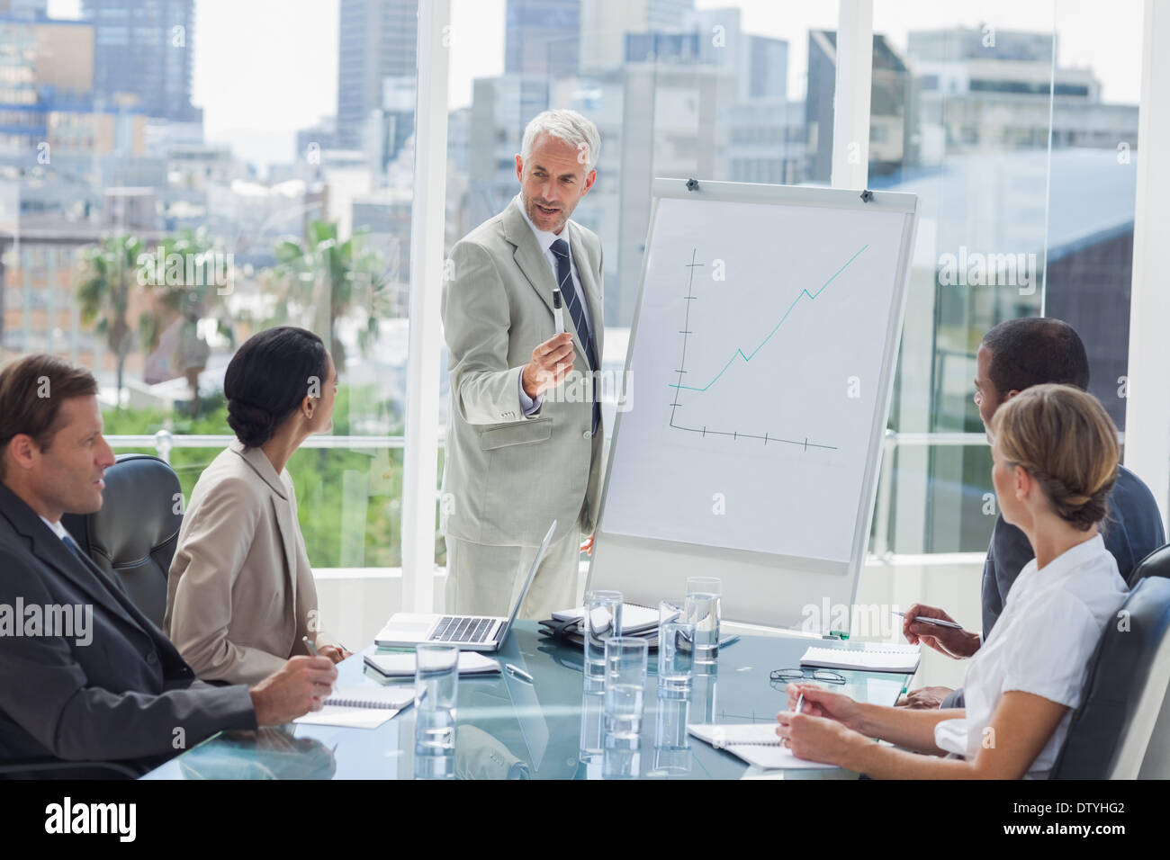 Serious businessman giving a presentation Stock Photo - Alamy
