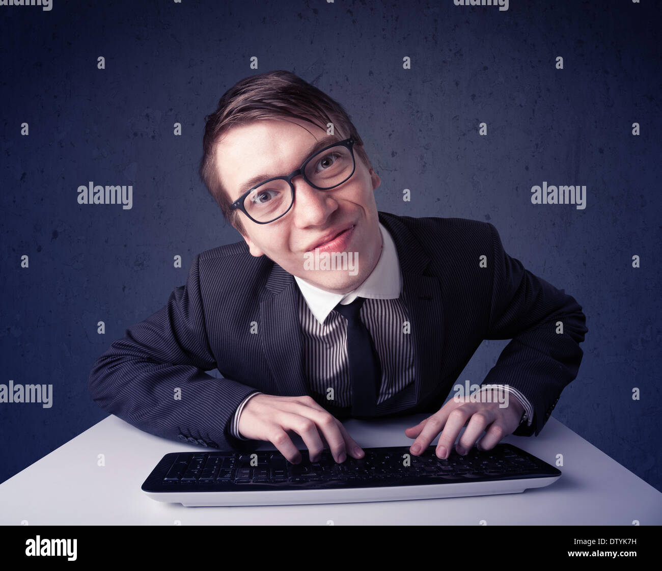 Hacker working with keyboard on blue background Stock Photo - Alamy