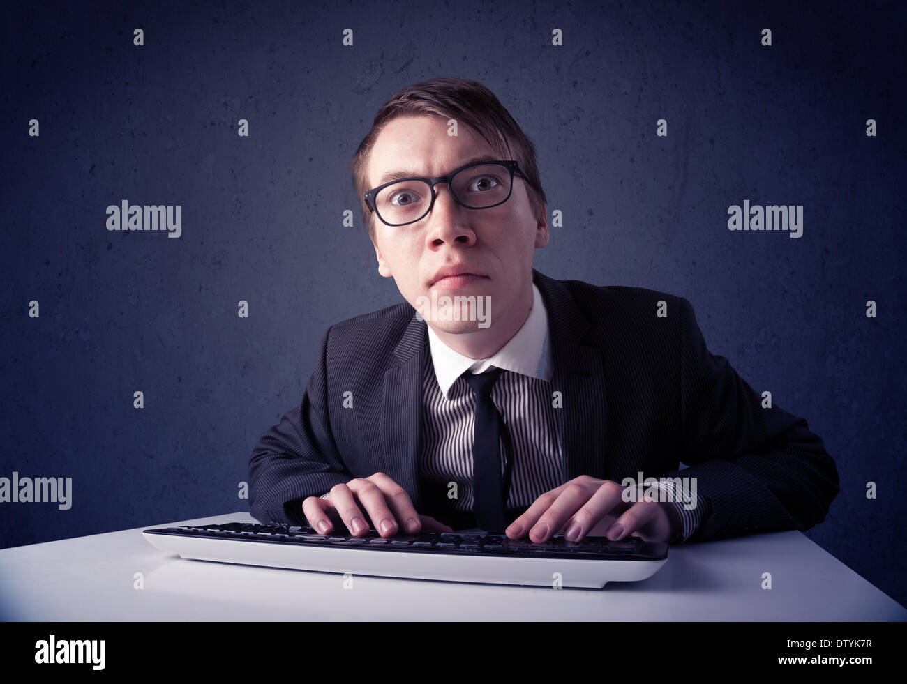 Hacker working with keyboard on blue background Stock Photo - Alamy