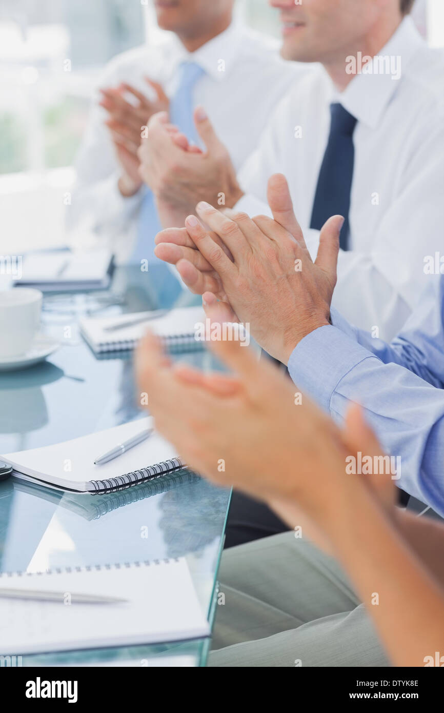 Business people clapping together Stock Photo - Alamy