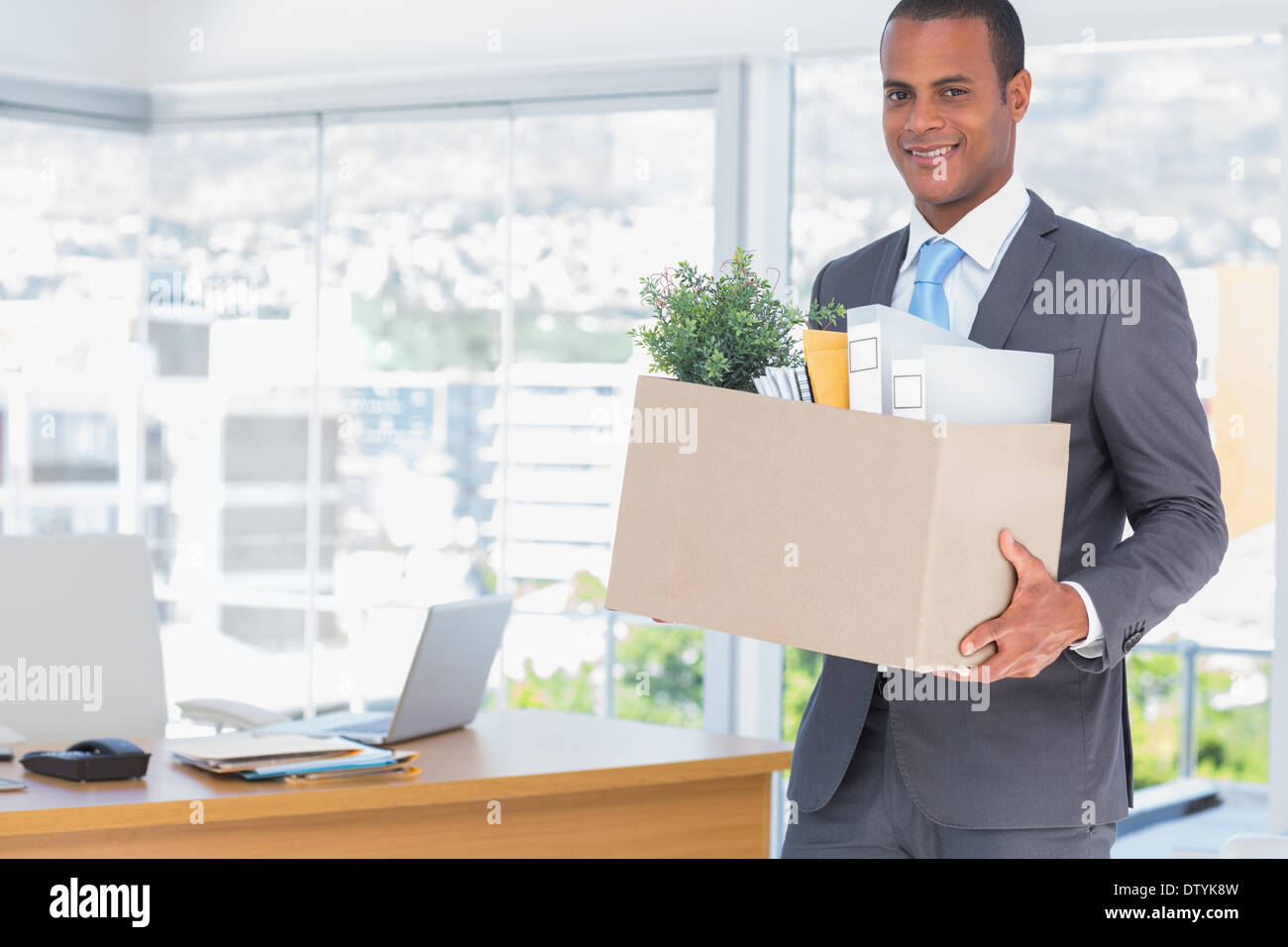 Smiling businessman leaving his company Stock Photo - Alamy