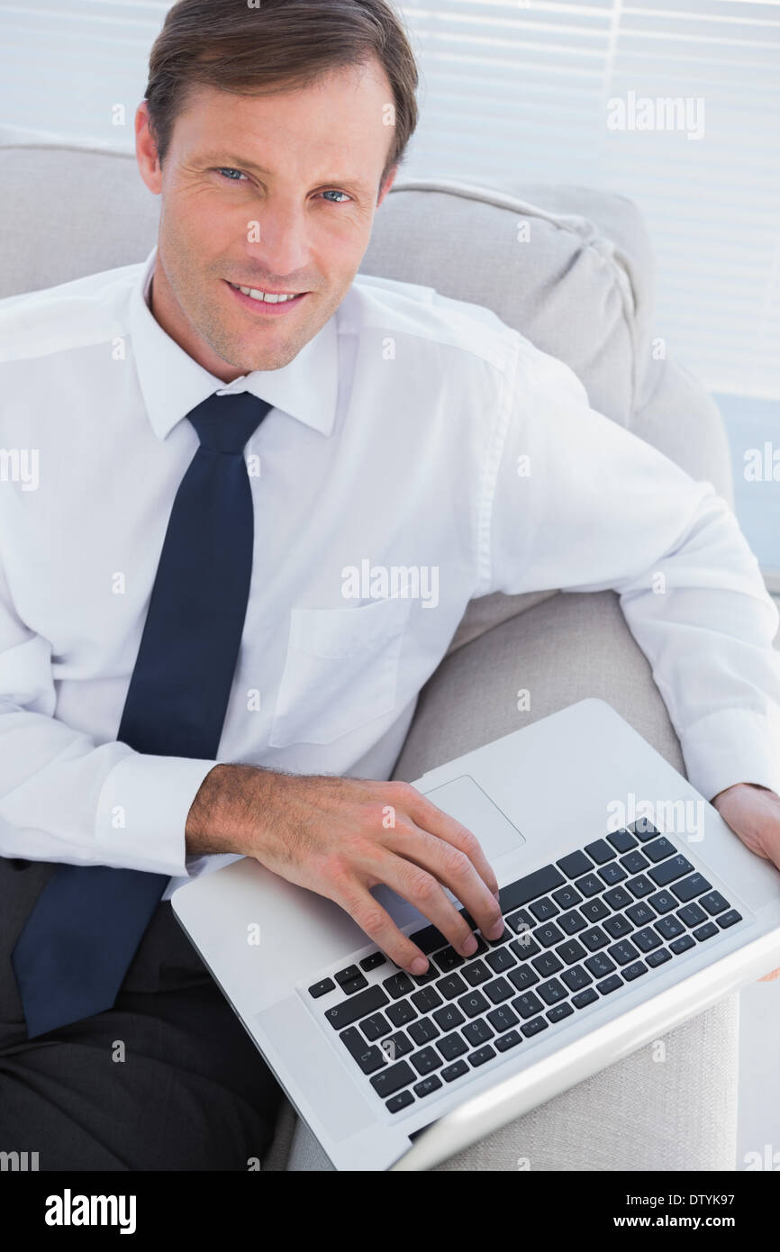 Cheerful businessman typing on notebook hi-res stock photography and ...