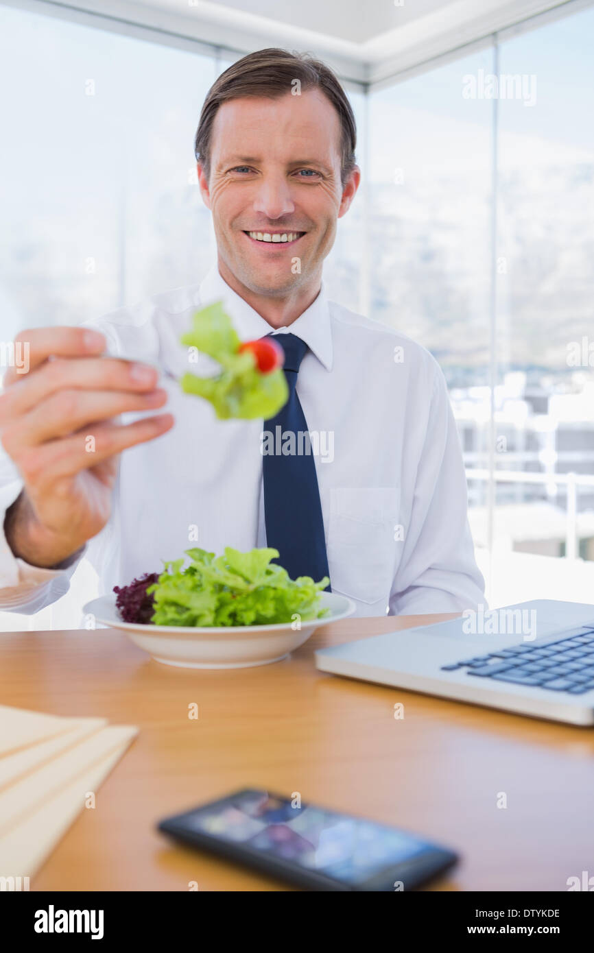 Cheerful businessman eating salad hi-res stock photography and images ...